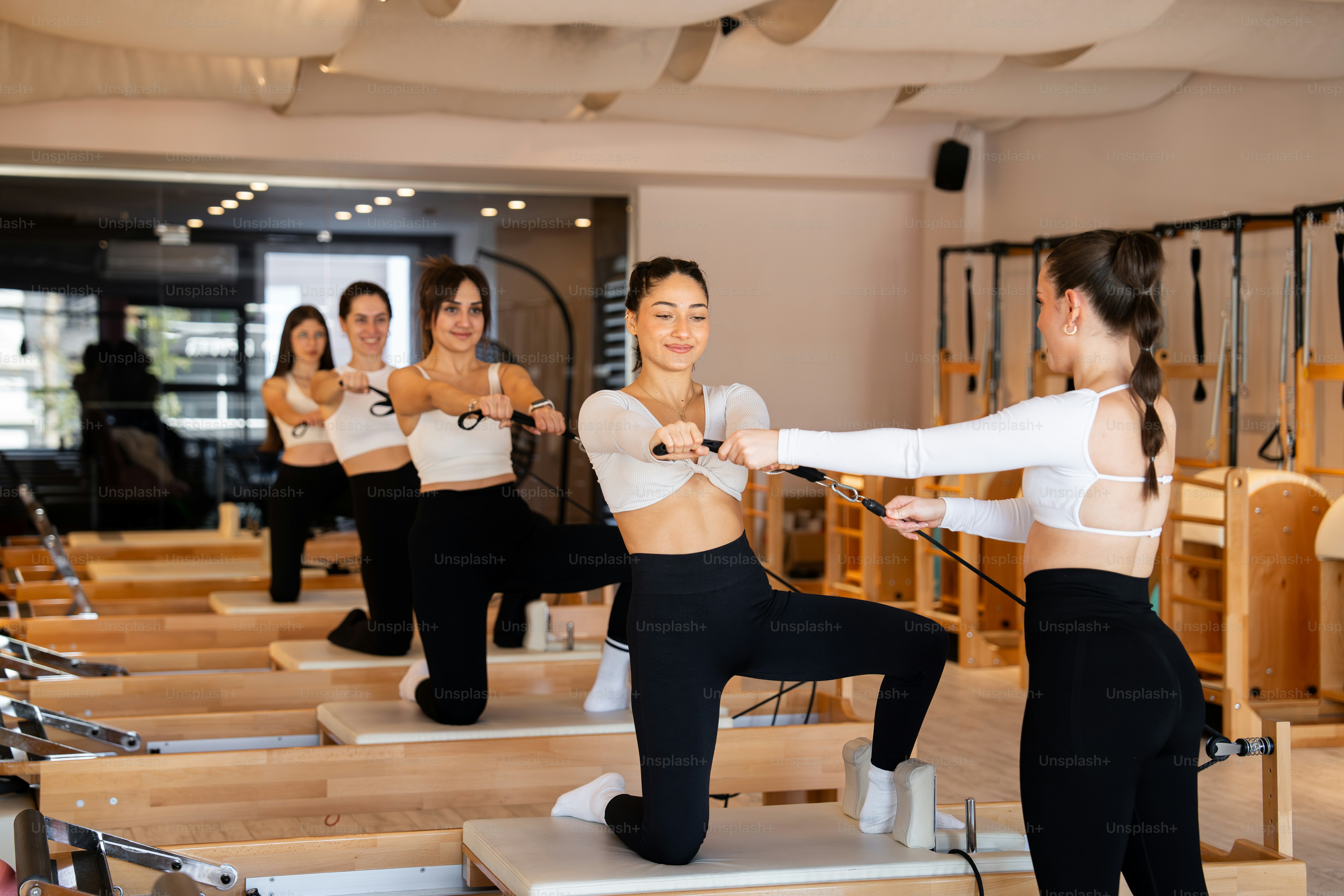 A group of women practicing yoga in a gym photo – Fitness classes Image ...