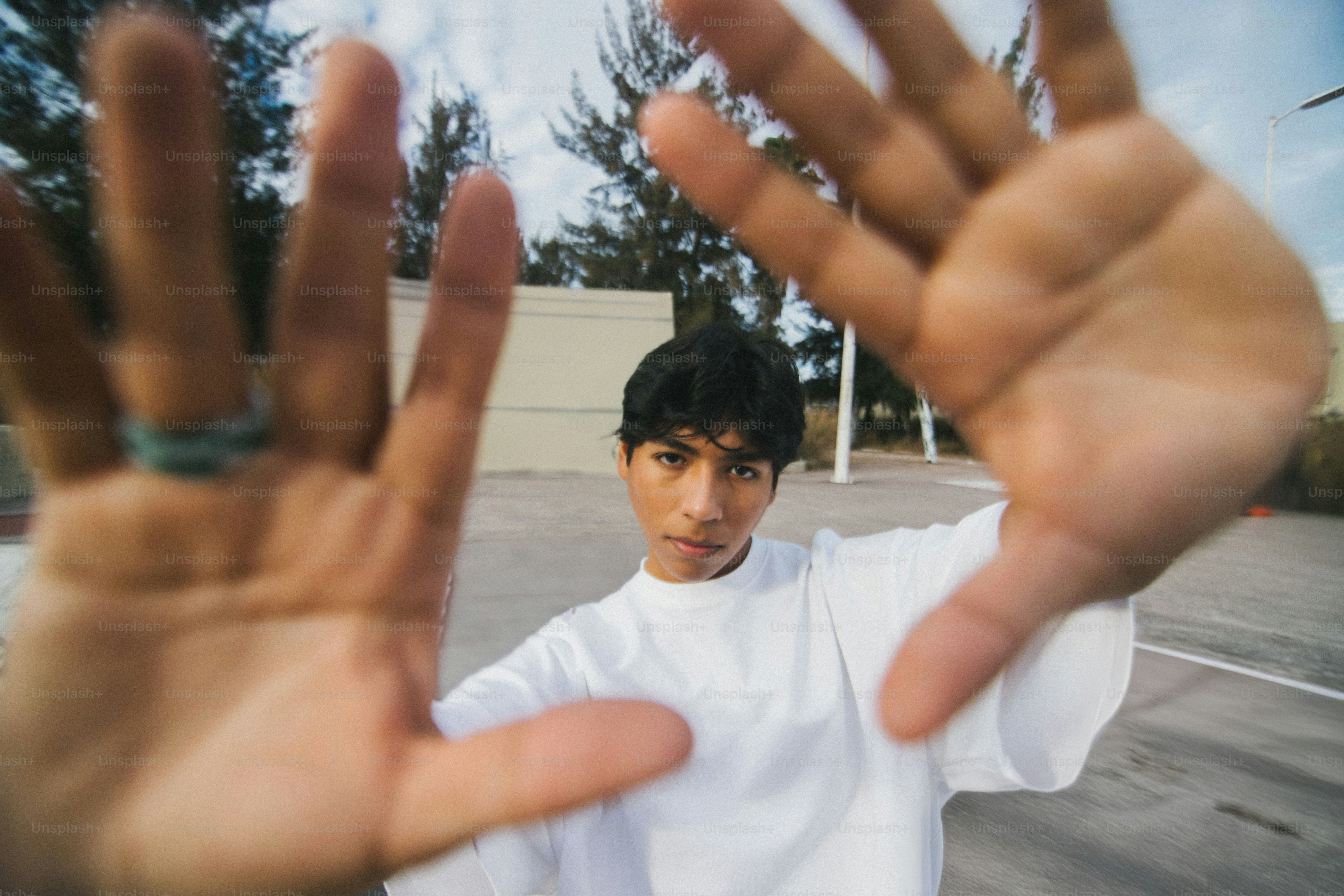 A man making a hand gesture with his fingers photo – Portrait Image on ...