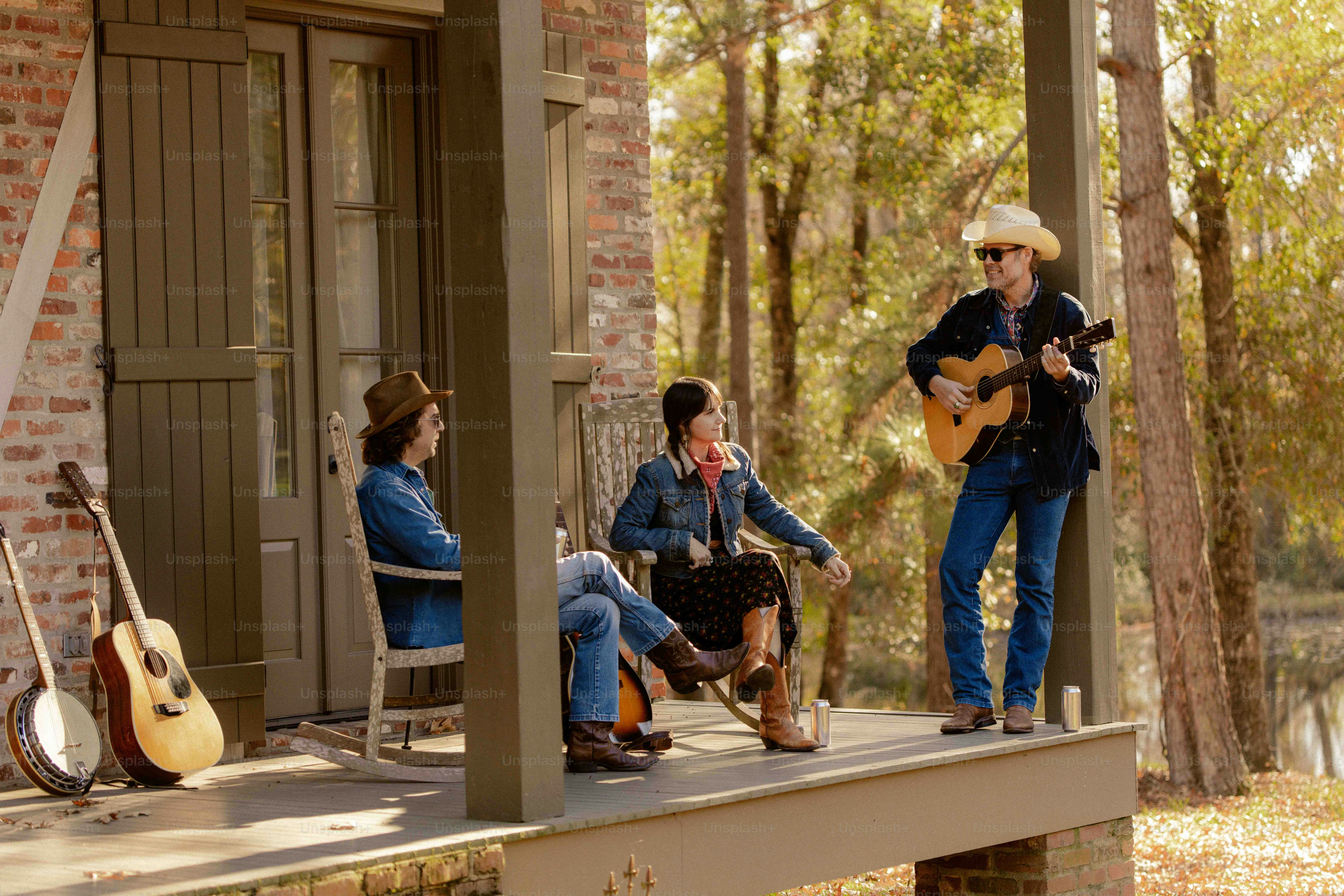 A group of people that are sitting on a porch photo – Country music ...