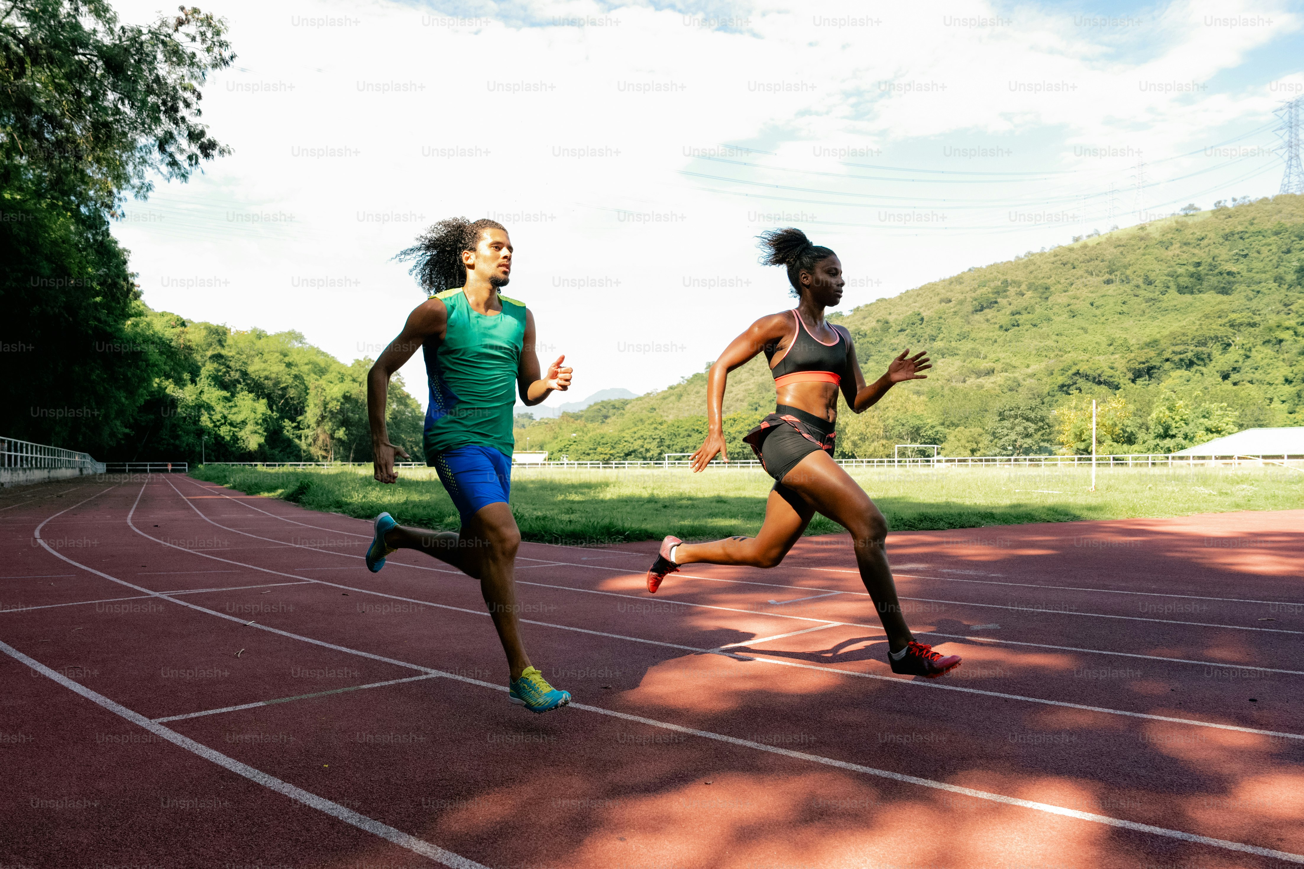 A couple of people that are running on a track photo – Running Image on ...