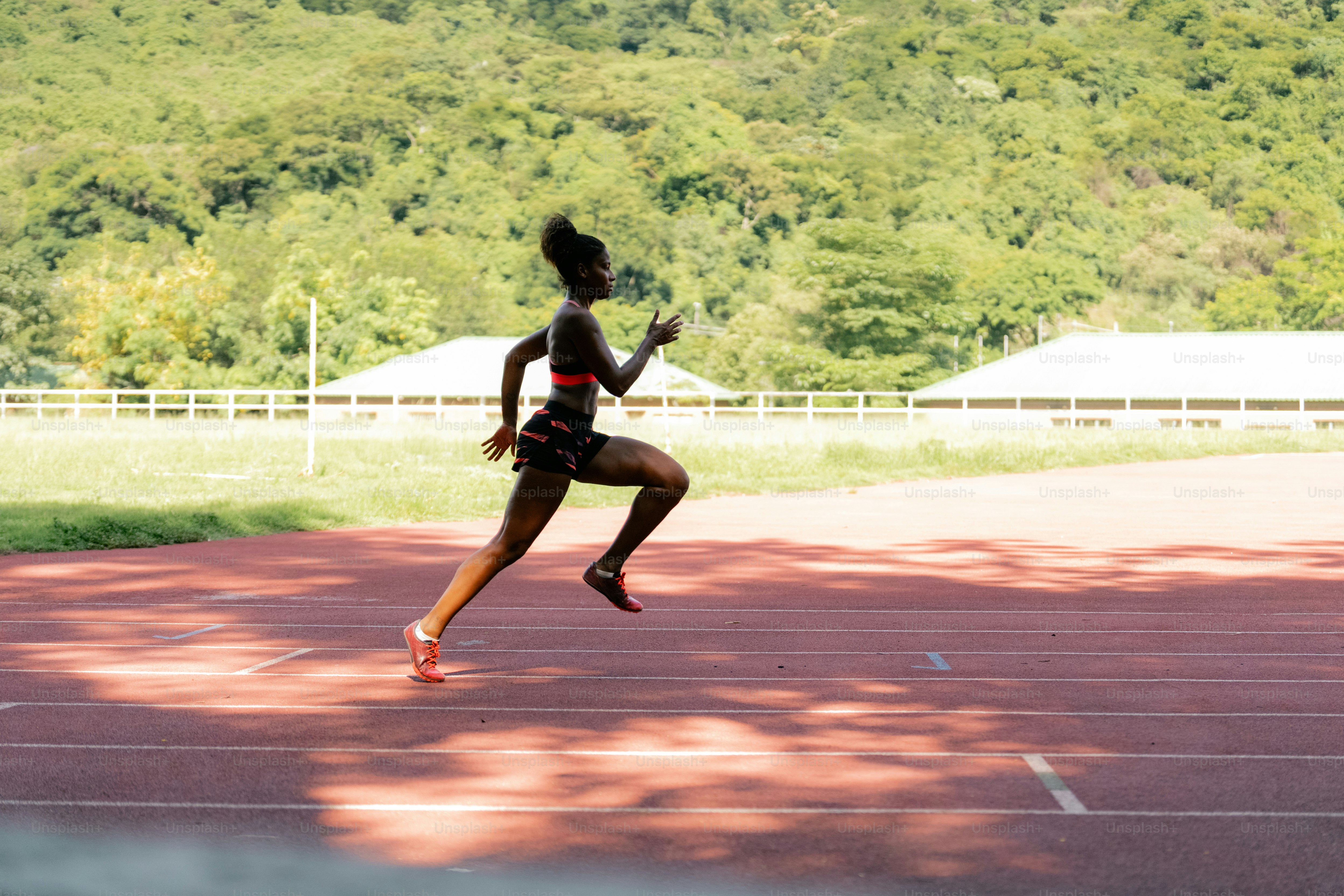 A woman running on a track in a park photo – Race track Image on Unsplash