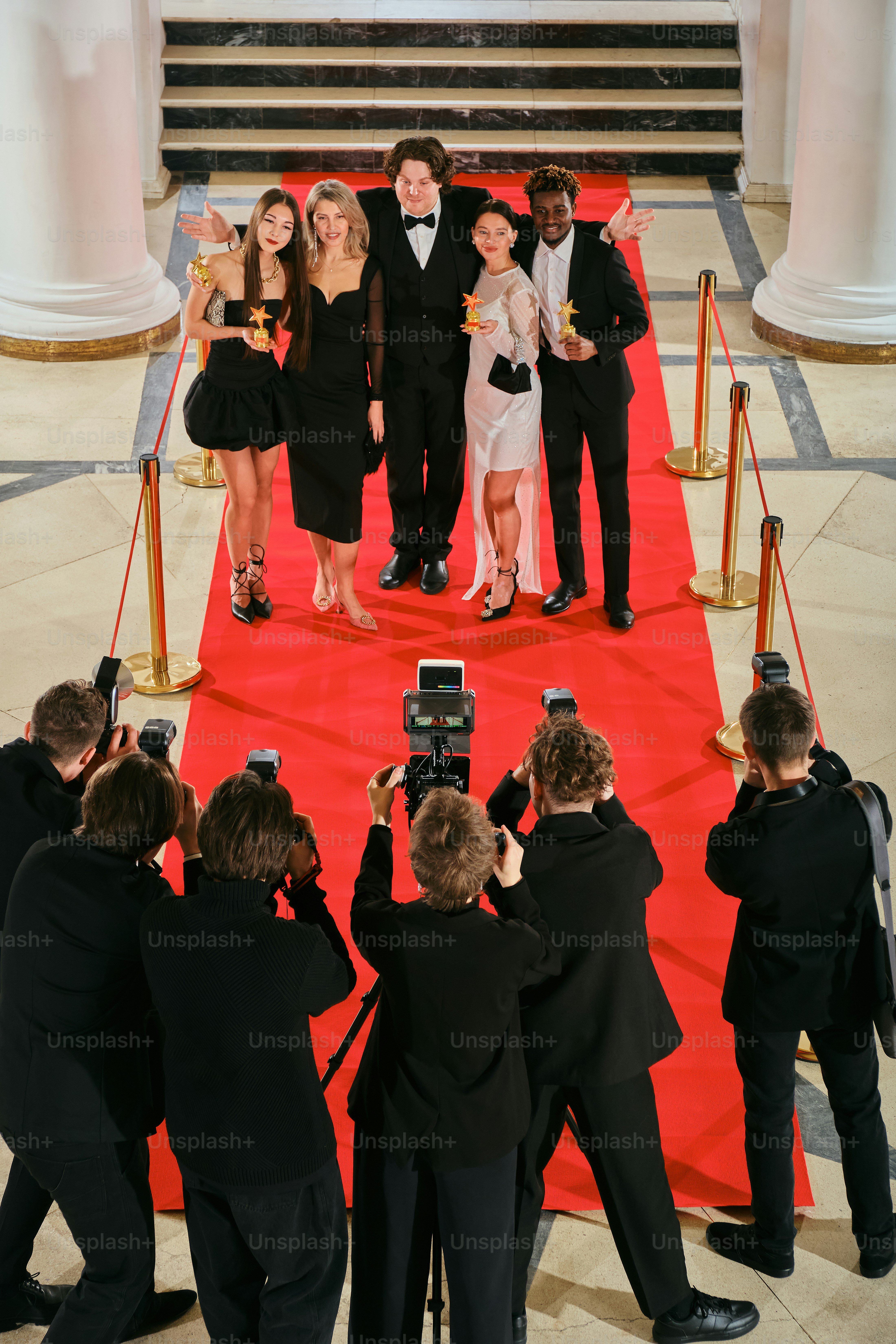 A group of people taking pictures on a red carpet photo – Award Image ...
