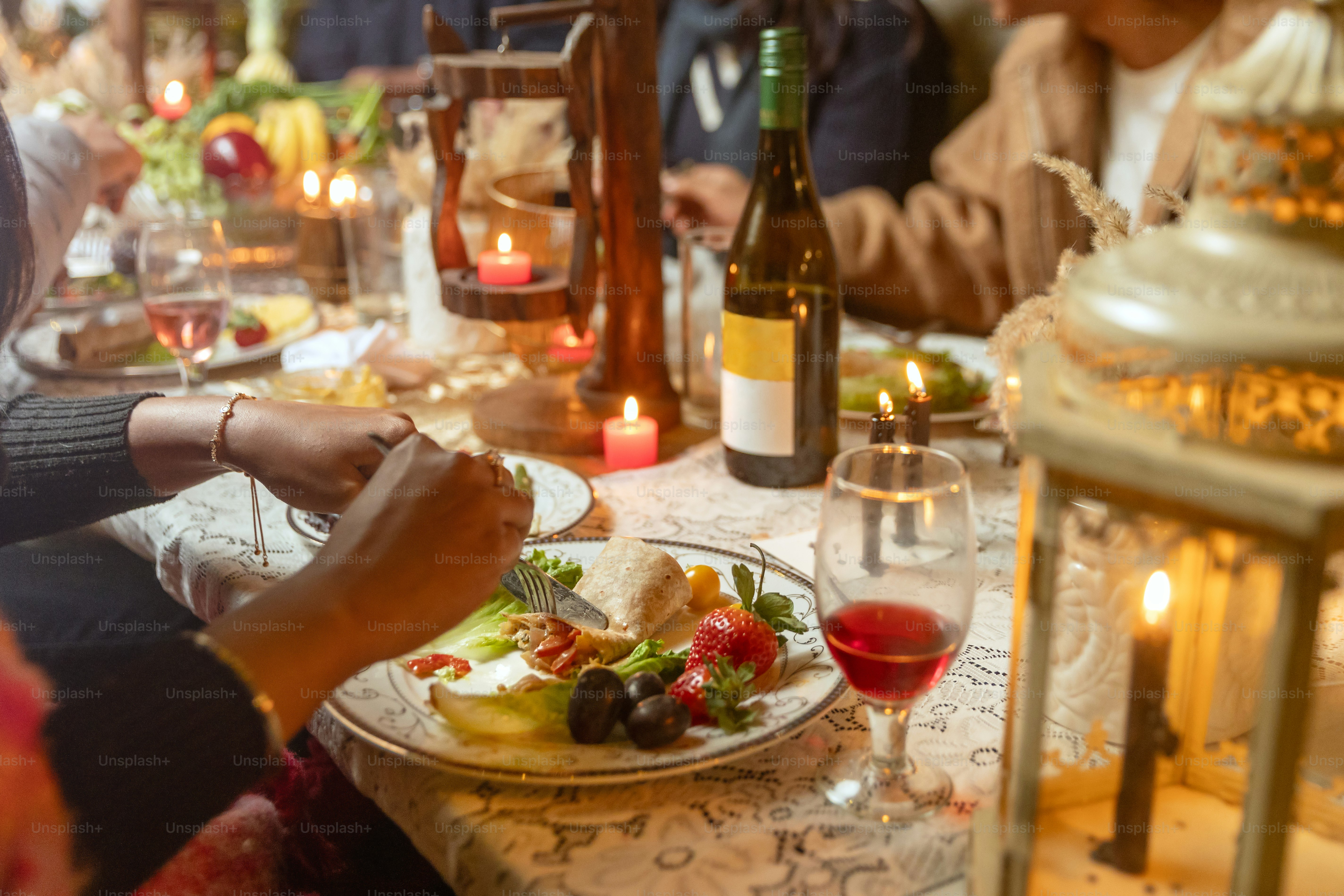 A group of people sitting around a dinner table photo – Gurugram Image ...