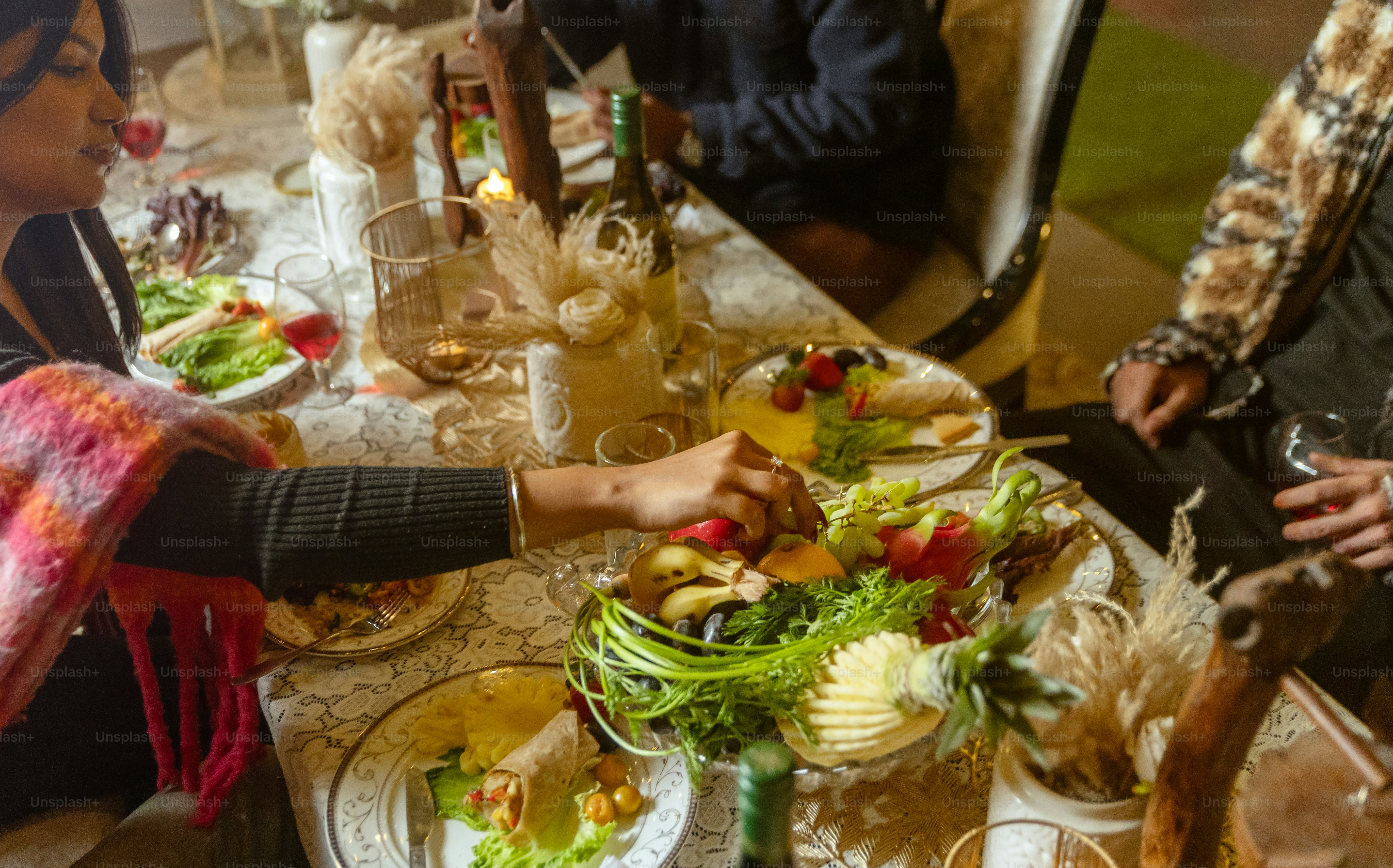 A group of people sitting around a dinner table photo – Eating Image on ...