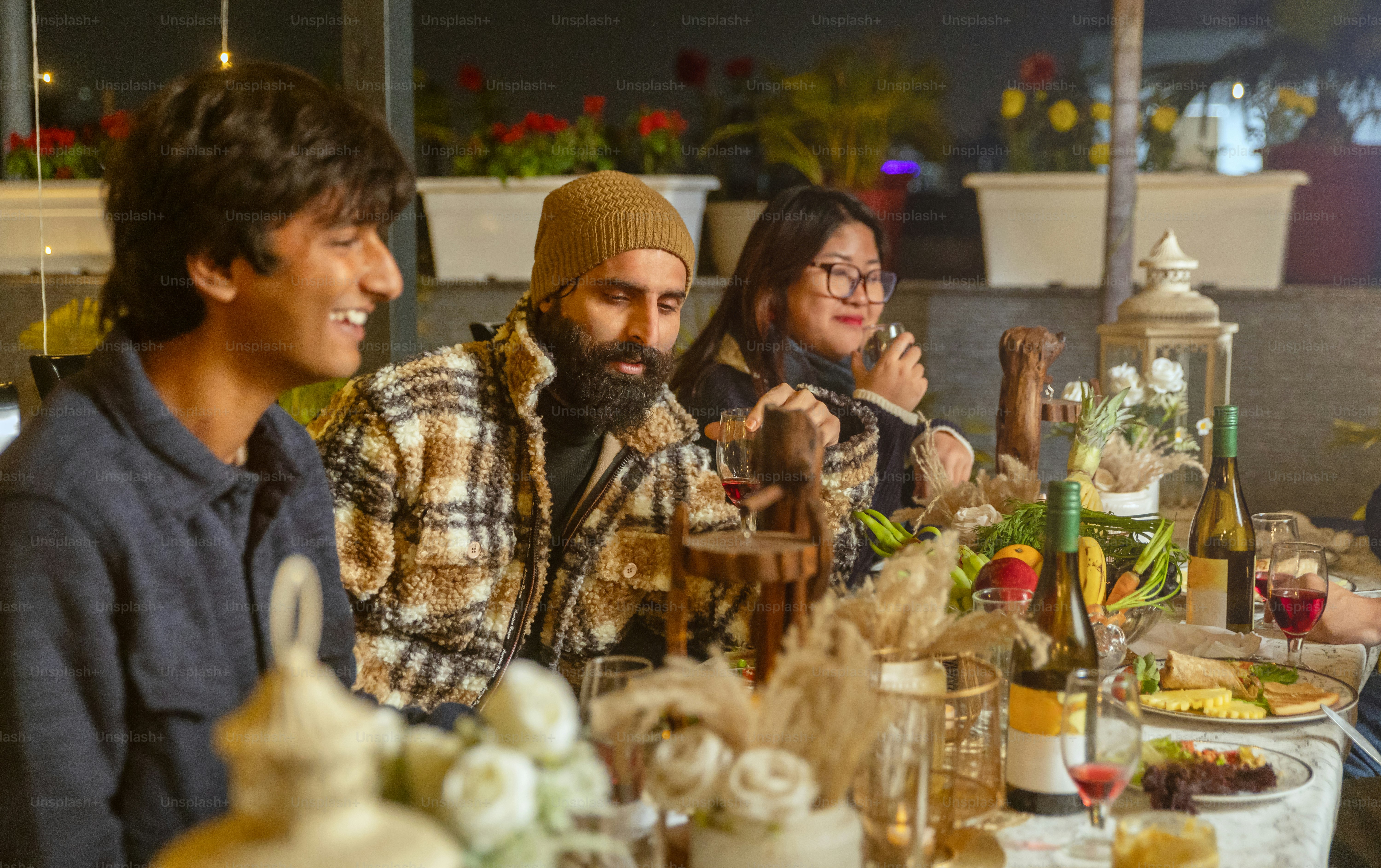 A group of people sitting around a dinner table photo – Friends Image ...