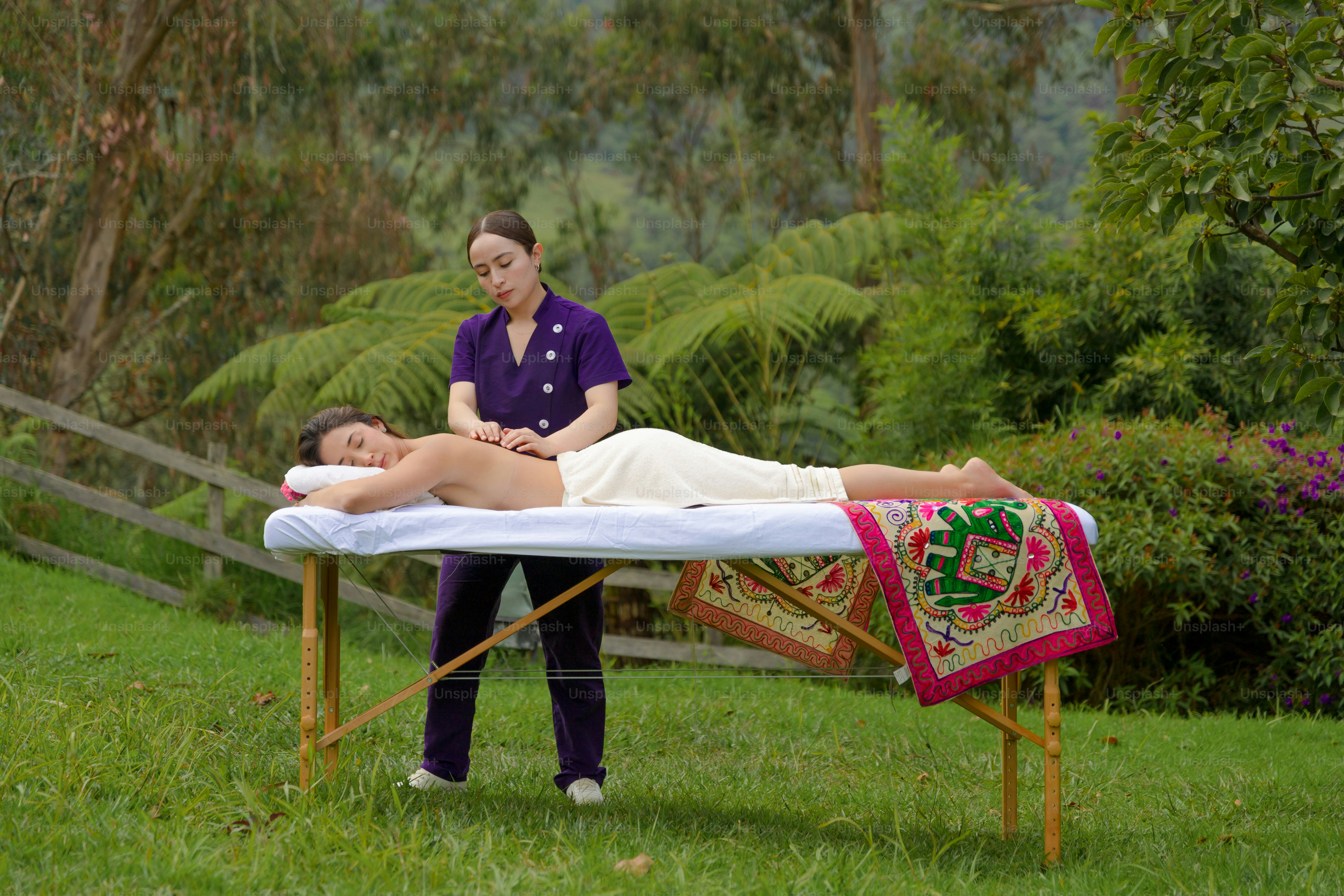 A woman getting a back massage in a field photo – Travel Image on Unsplash