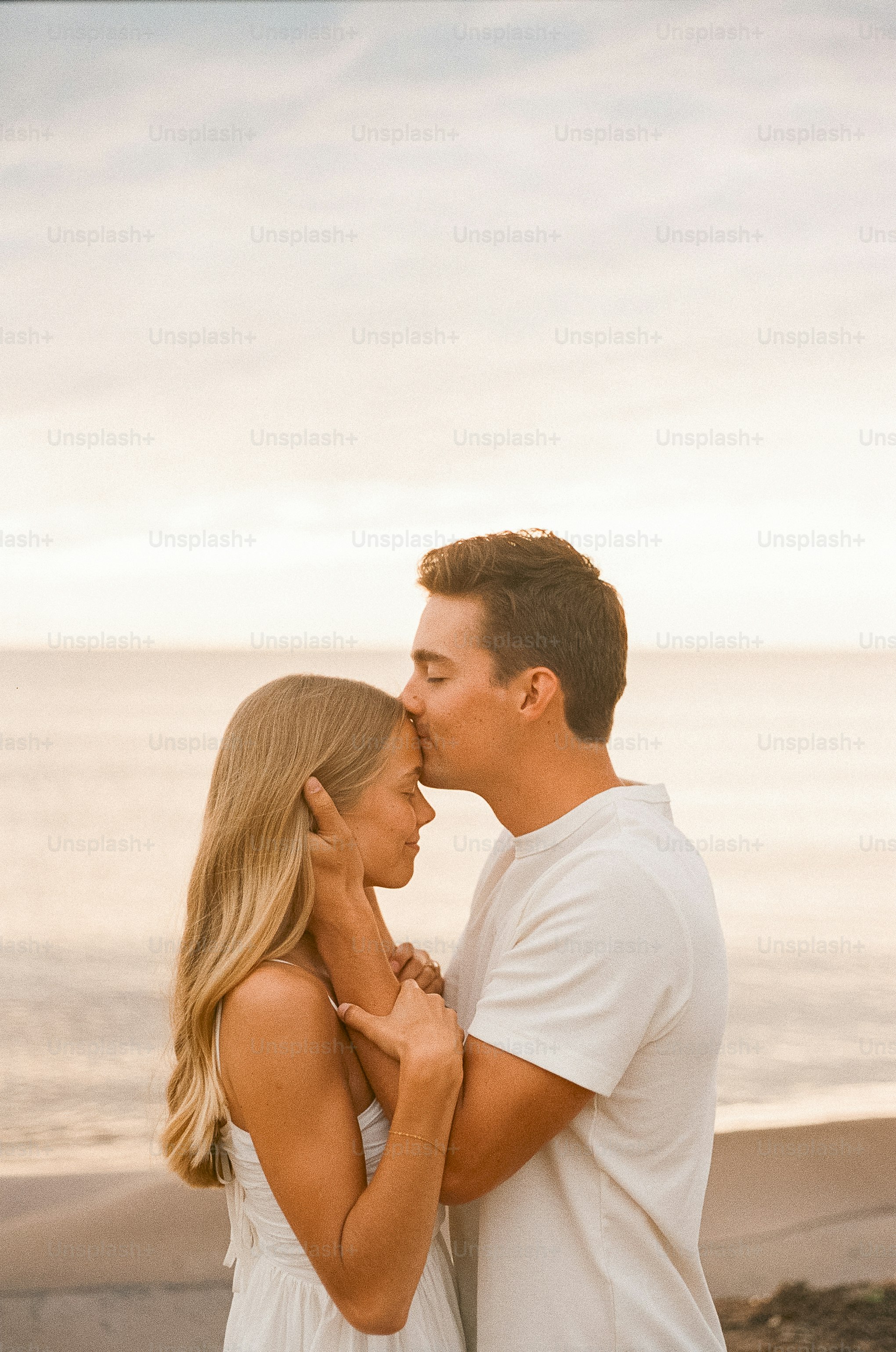 A man kisses a woman's forehead gently. photo – Love Image on Unsplash
