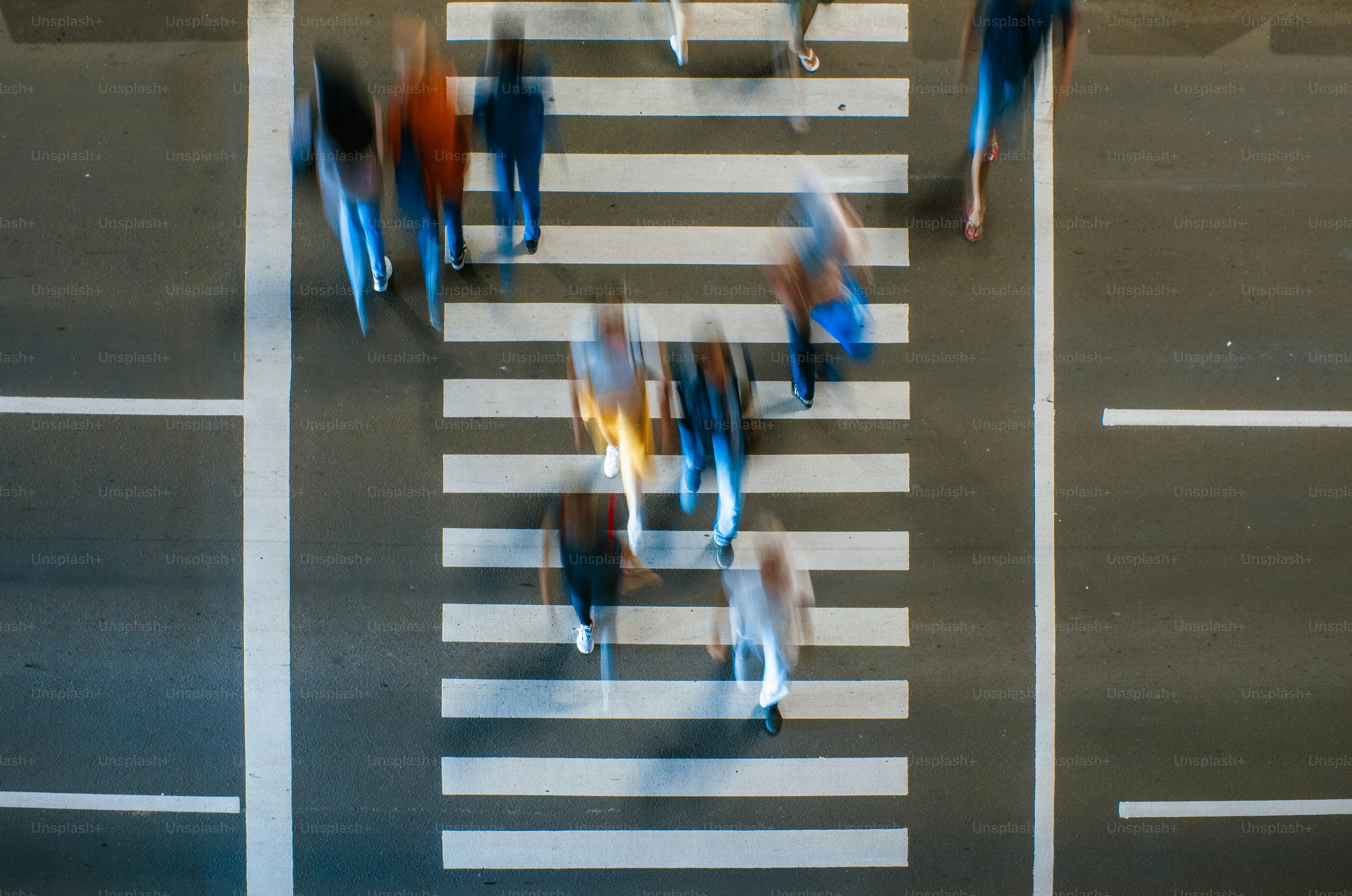 A group of people walking across a cross walk photo – Abstract Image on ...