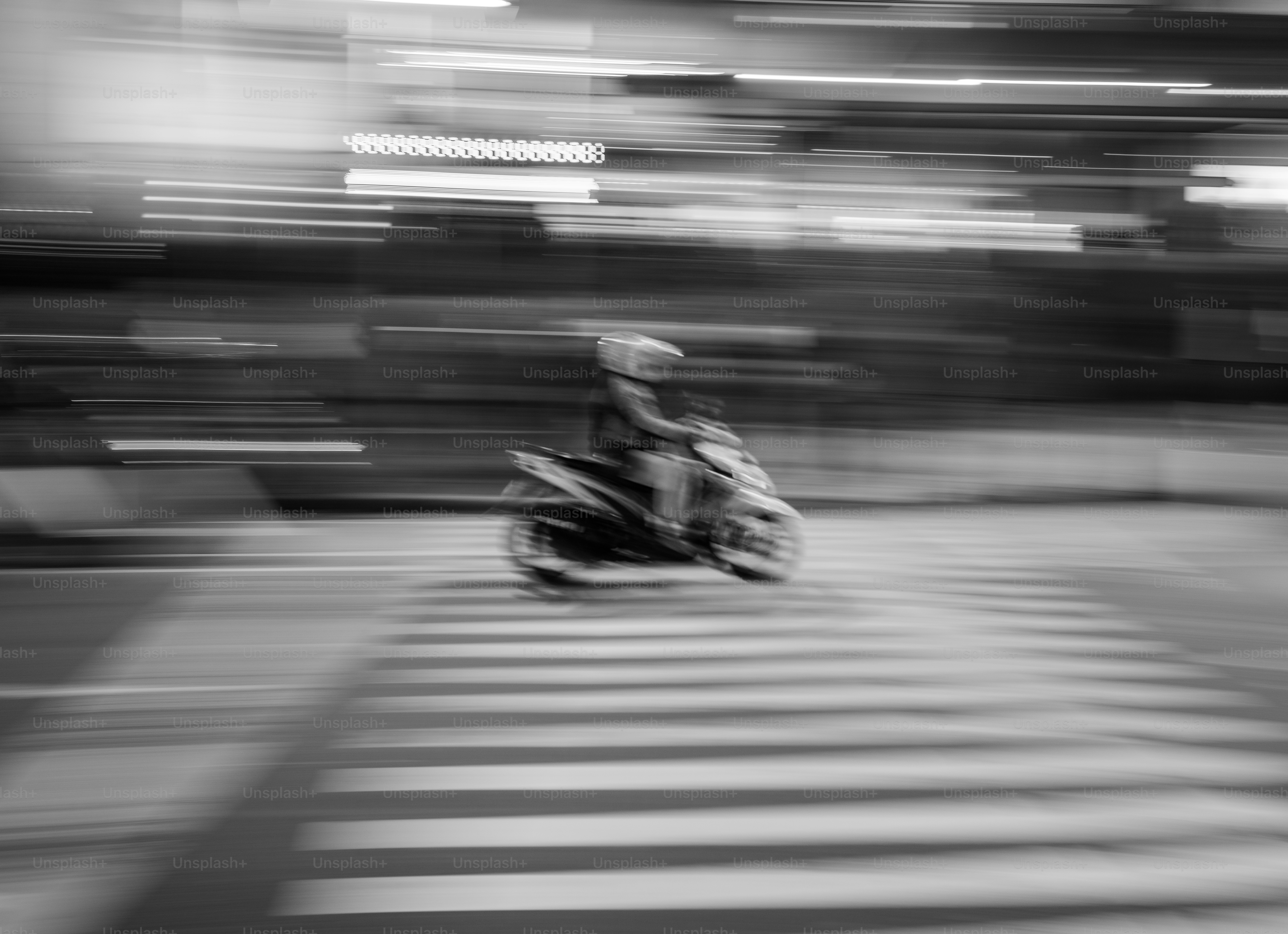 A blurry photo of a person riding a motorcycle photo – In motion Image ...