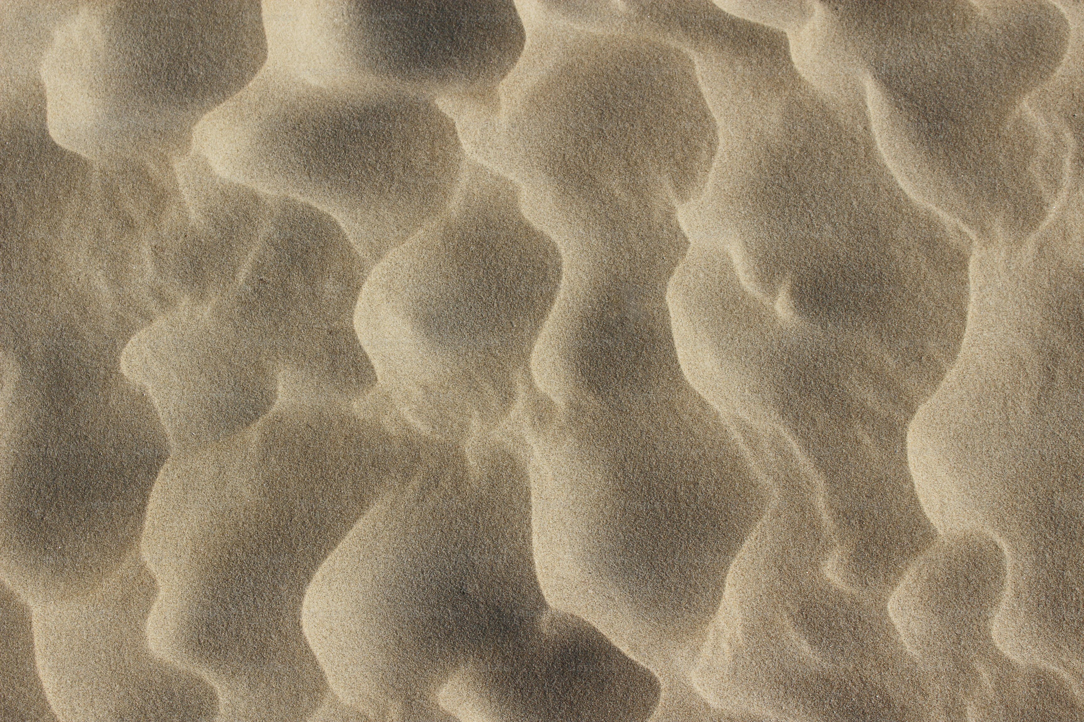 A close up view of sand and water photo – Beach Image on Unsplash