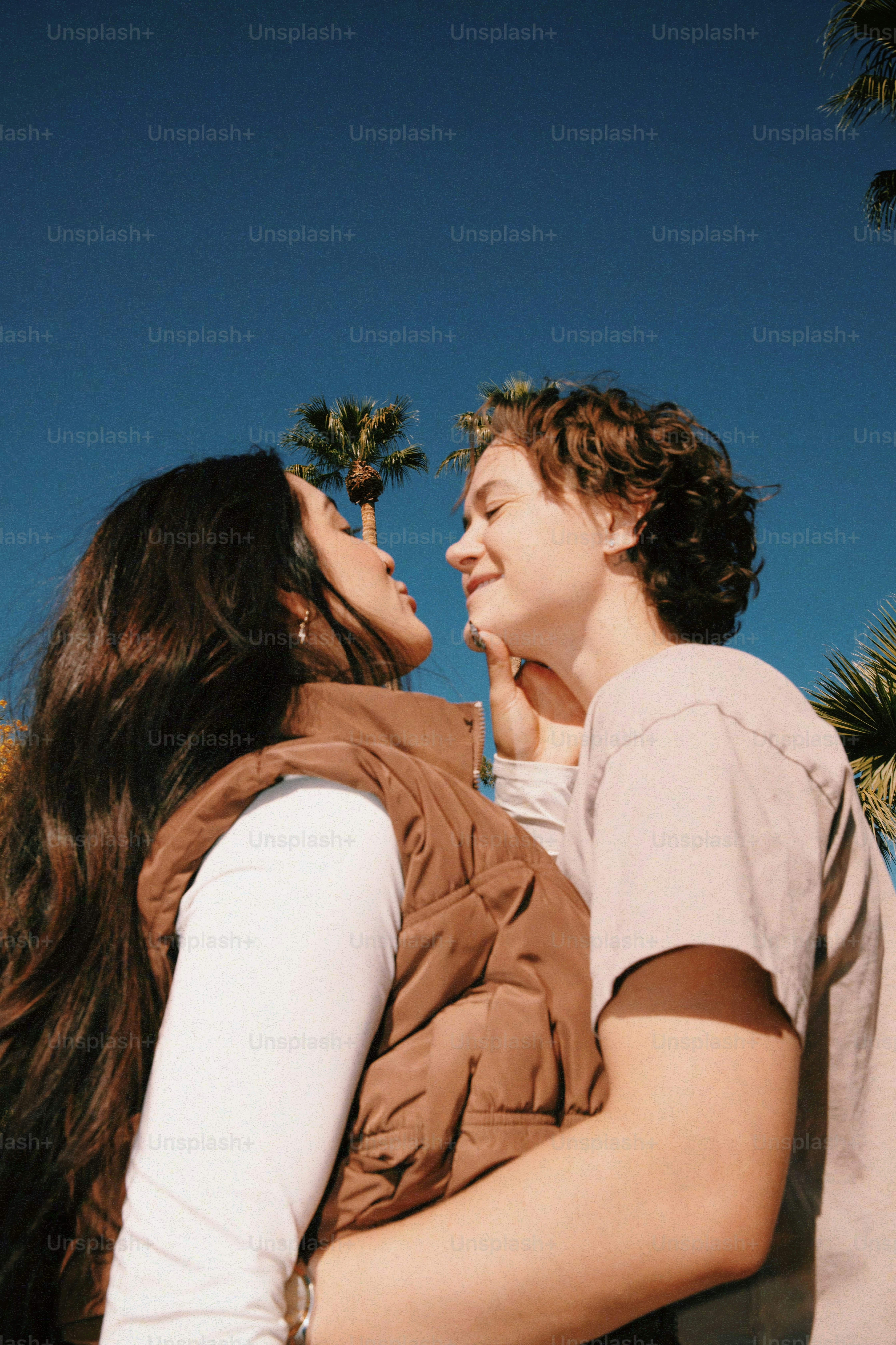 Couple lovingly gazing at each other under a blue sky. photo – Love ...