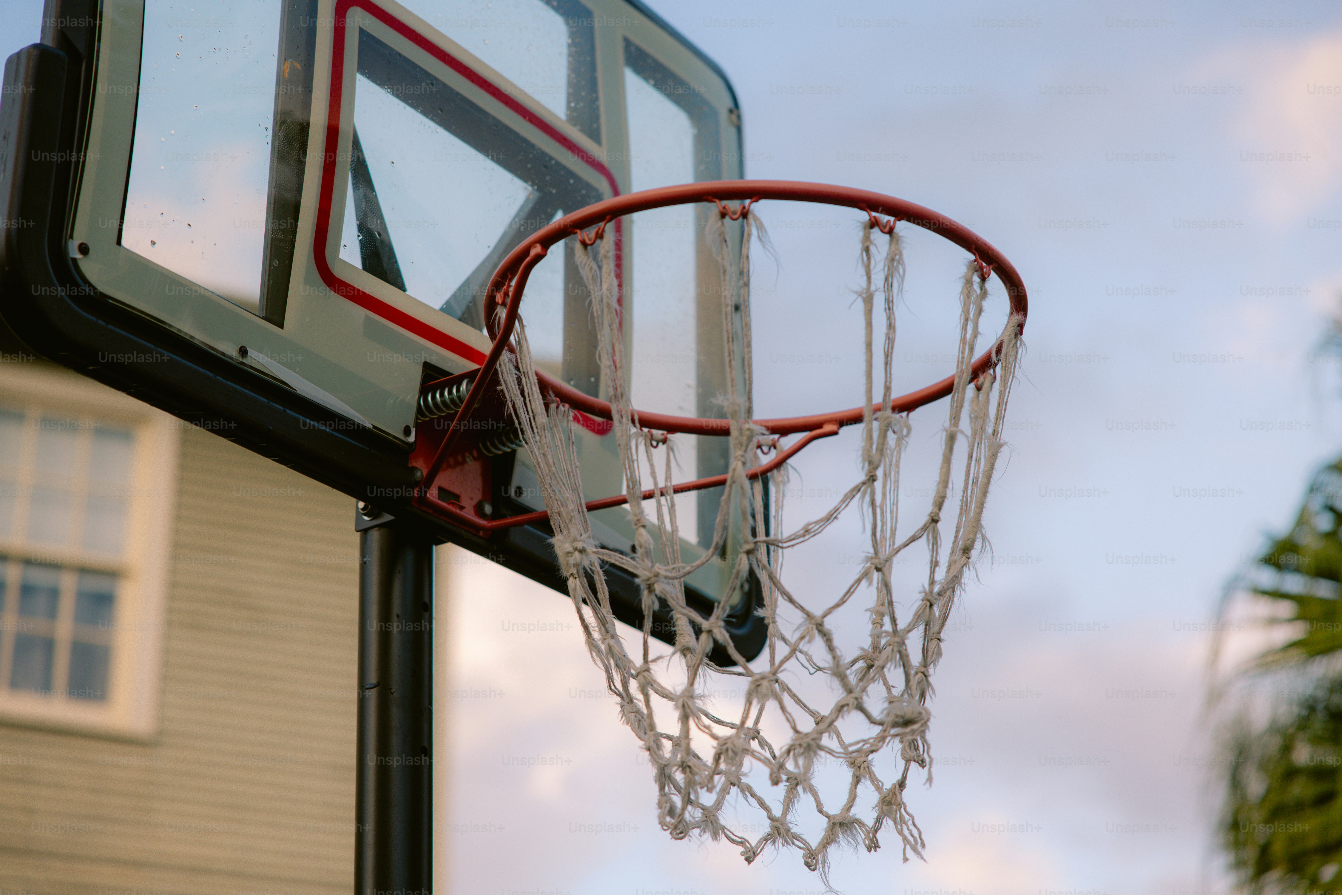 A basketball going through the hoop of a basketball hoop photo – Usa ...