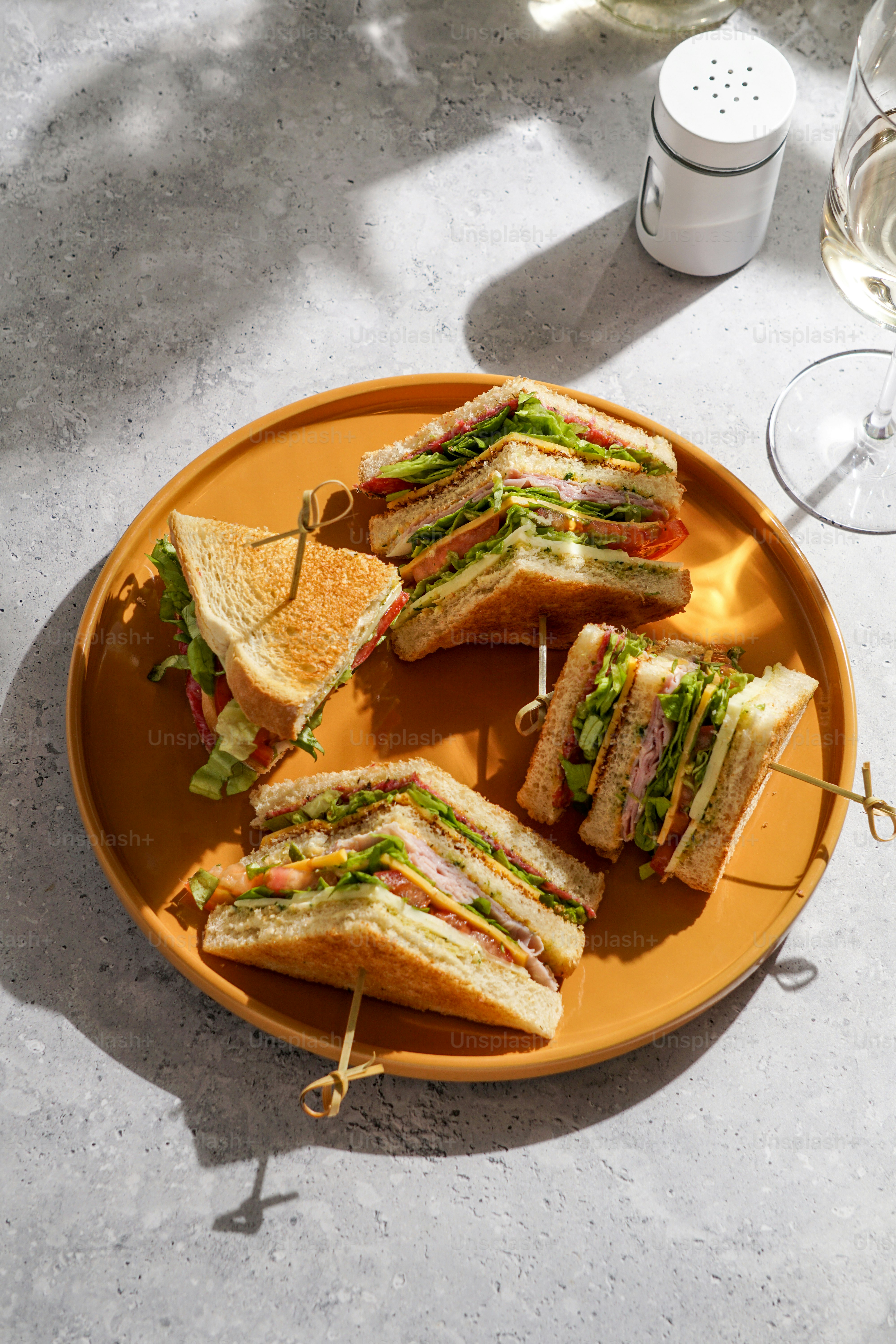 A plate with a cut in half sandwich on it photo – Sandwiches Image on ...