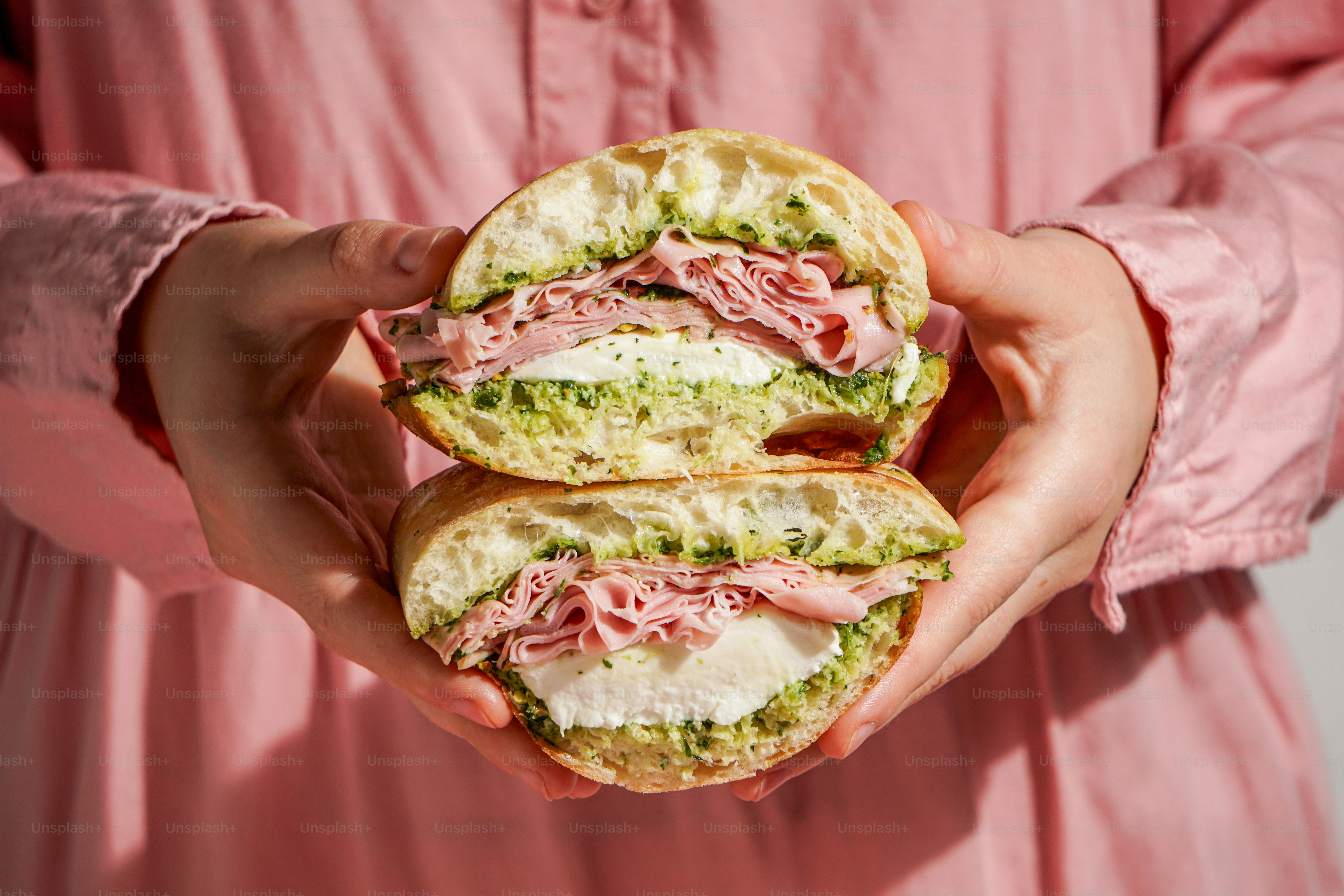 A person holding a sandwich in their hands photo – Sandwiches Image on ...