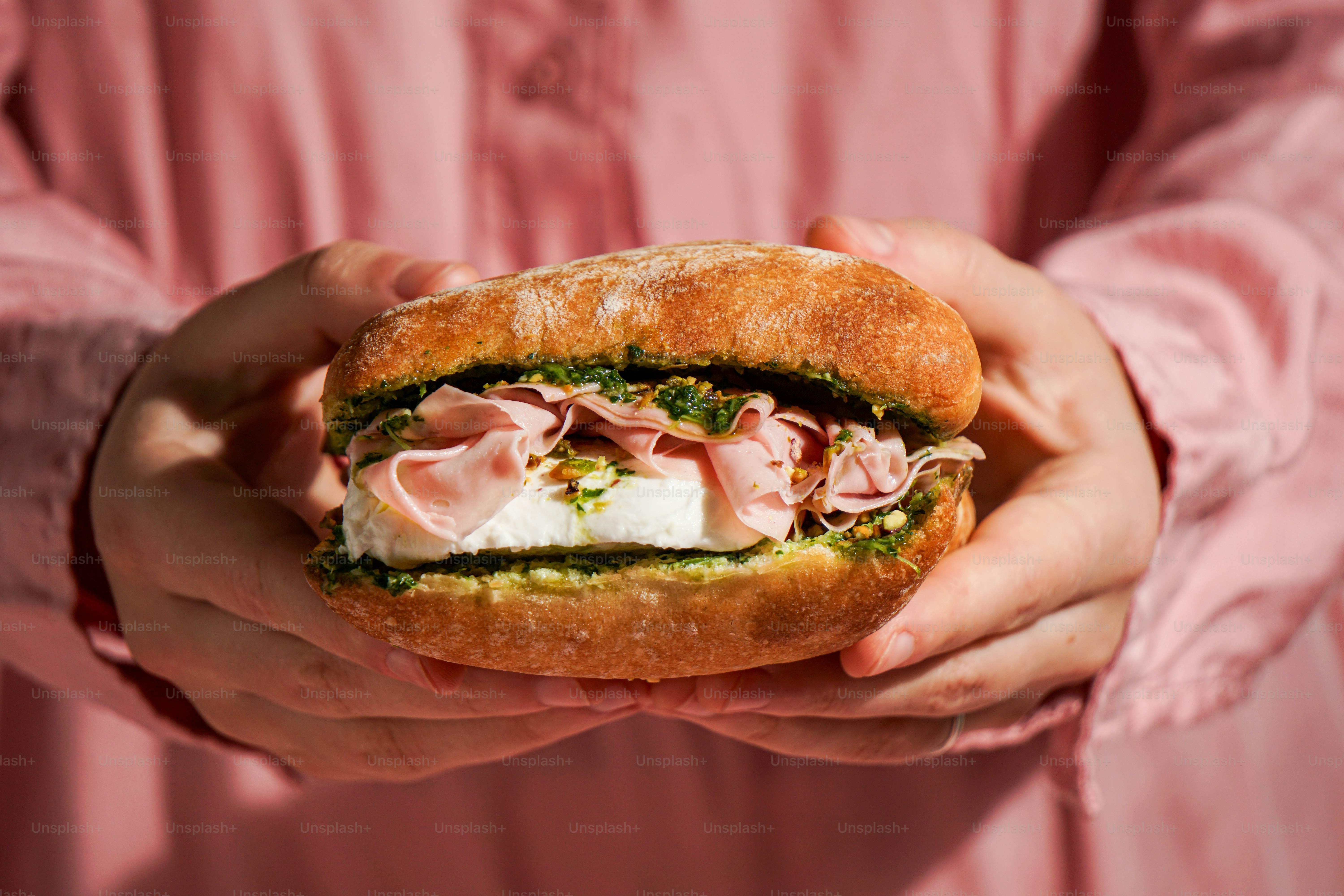 A person holding a sandwich in their hands photo – Sandwiches Image on ...