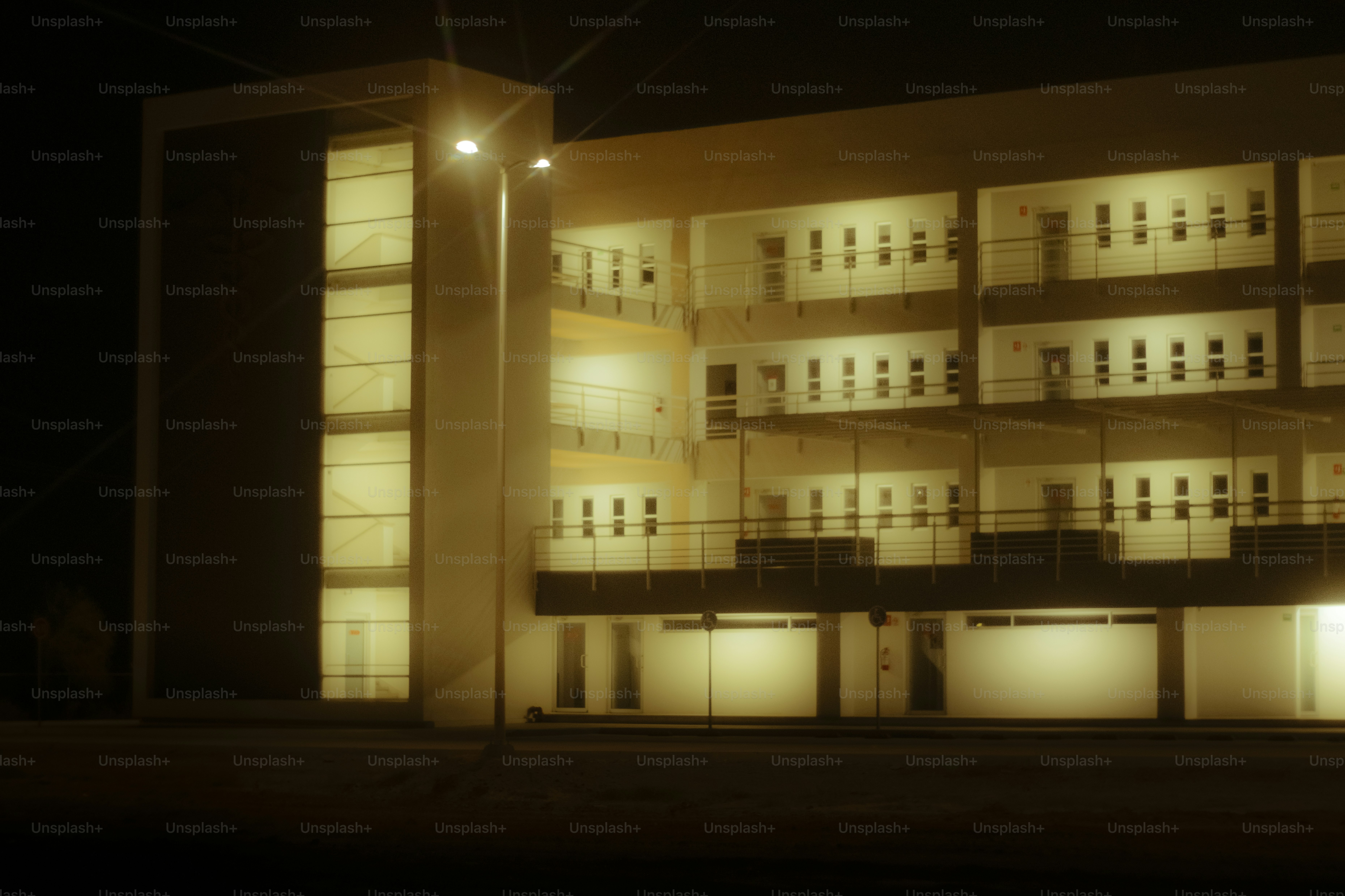 A building lit up at night with lights on photo – City Image on Unsplash