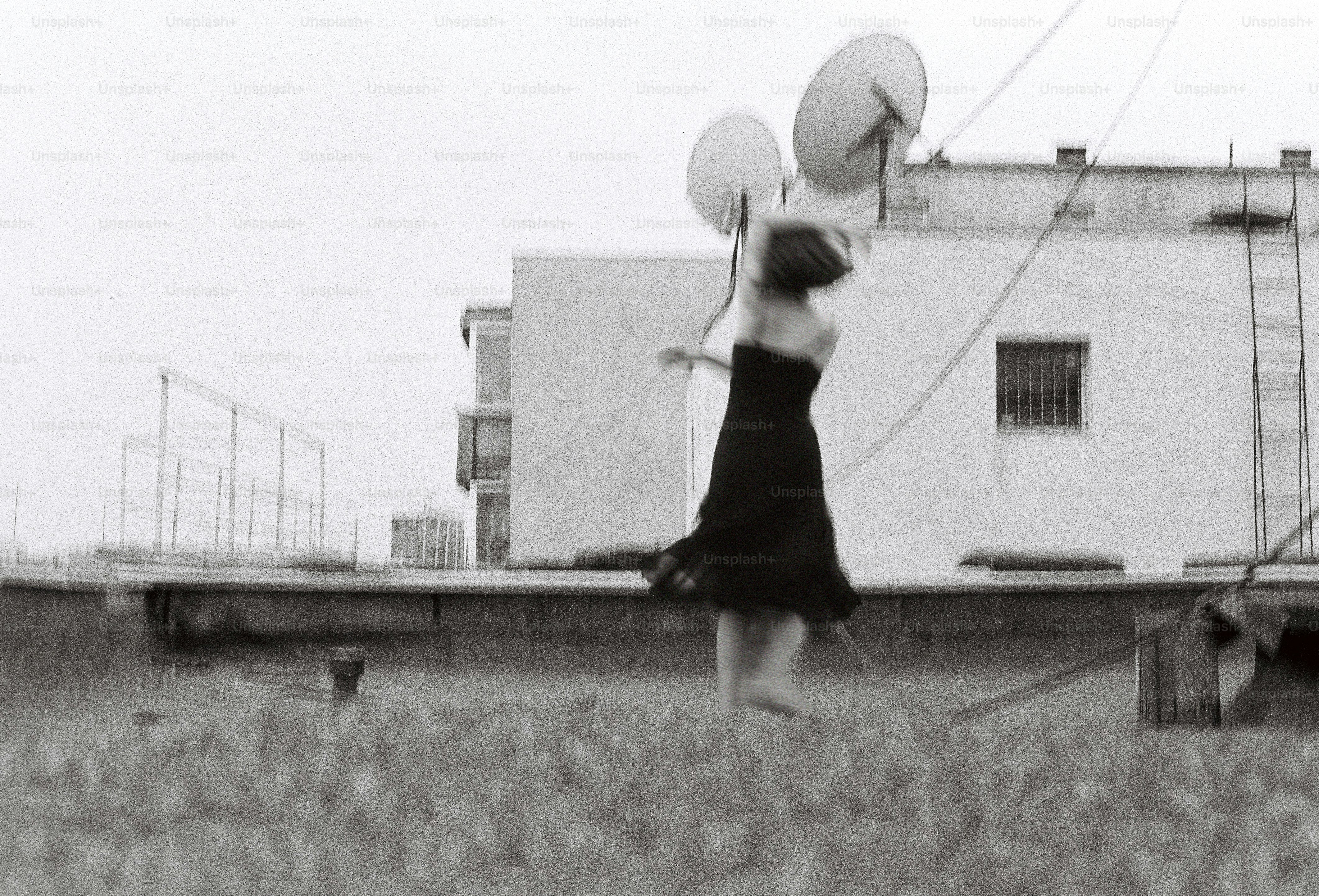 A woman in a black dress holding two balloons photo – Free Image on ...
