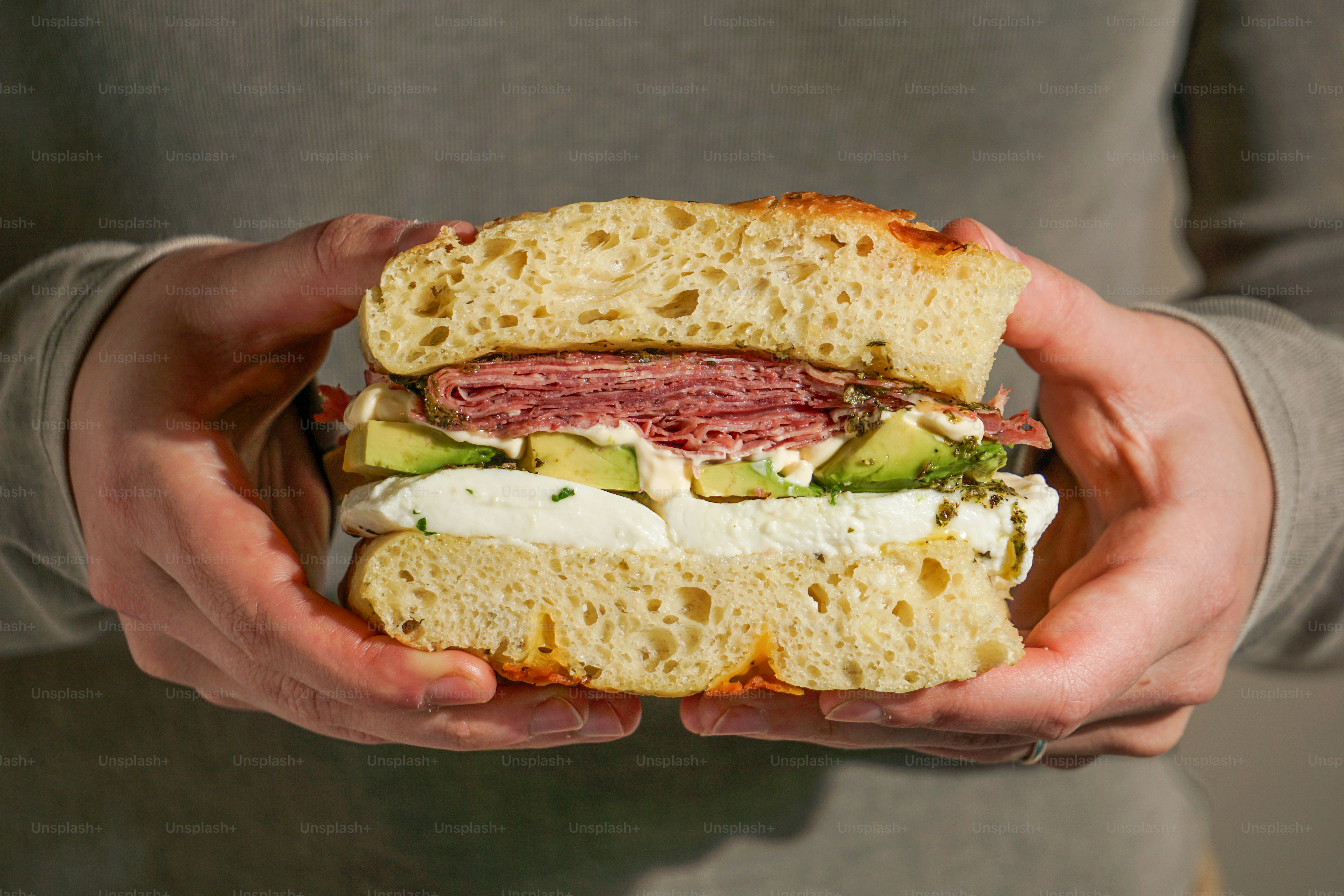 A person holding a sandwich in their hands photo – Sandwiches Image on ...