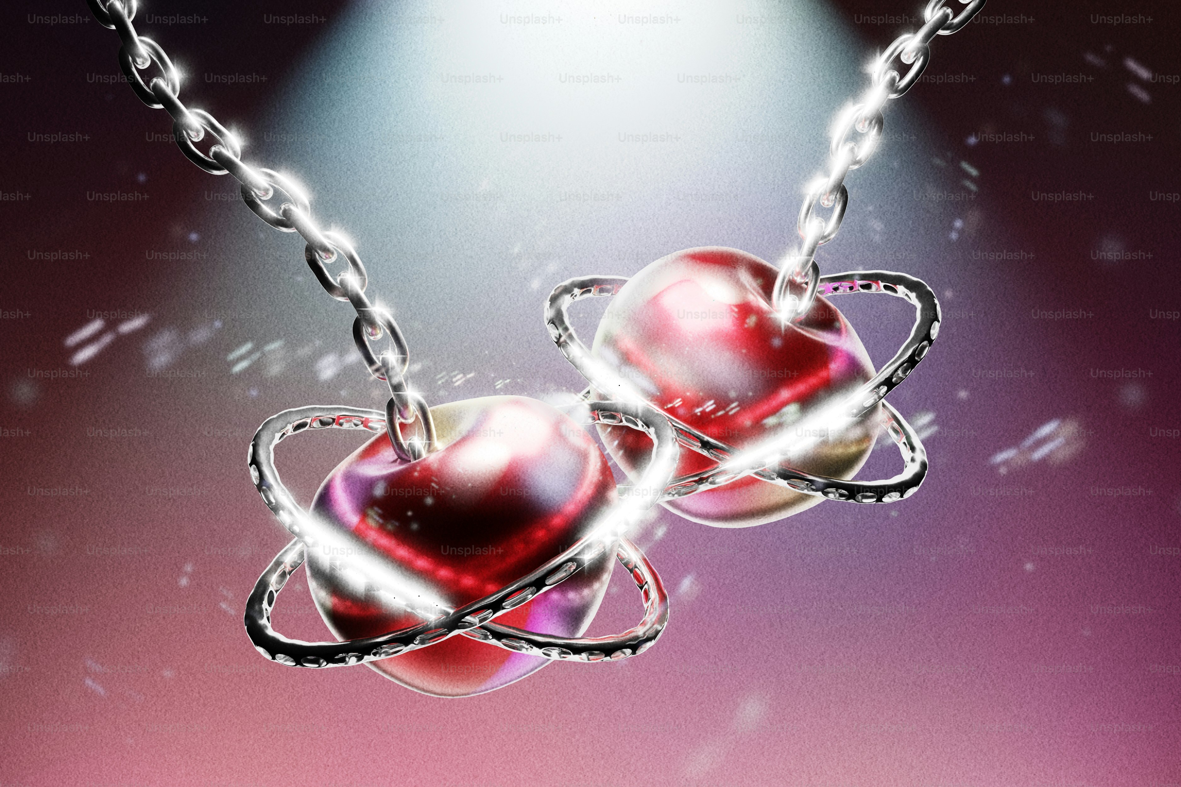 A couple of red hearts hanging from a chain photo – Abstract Image on ...