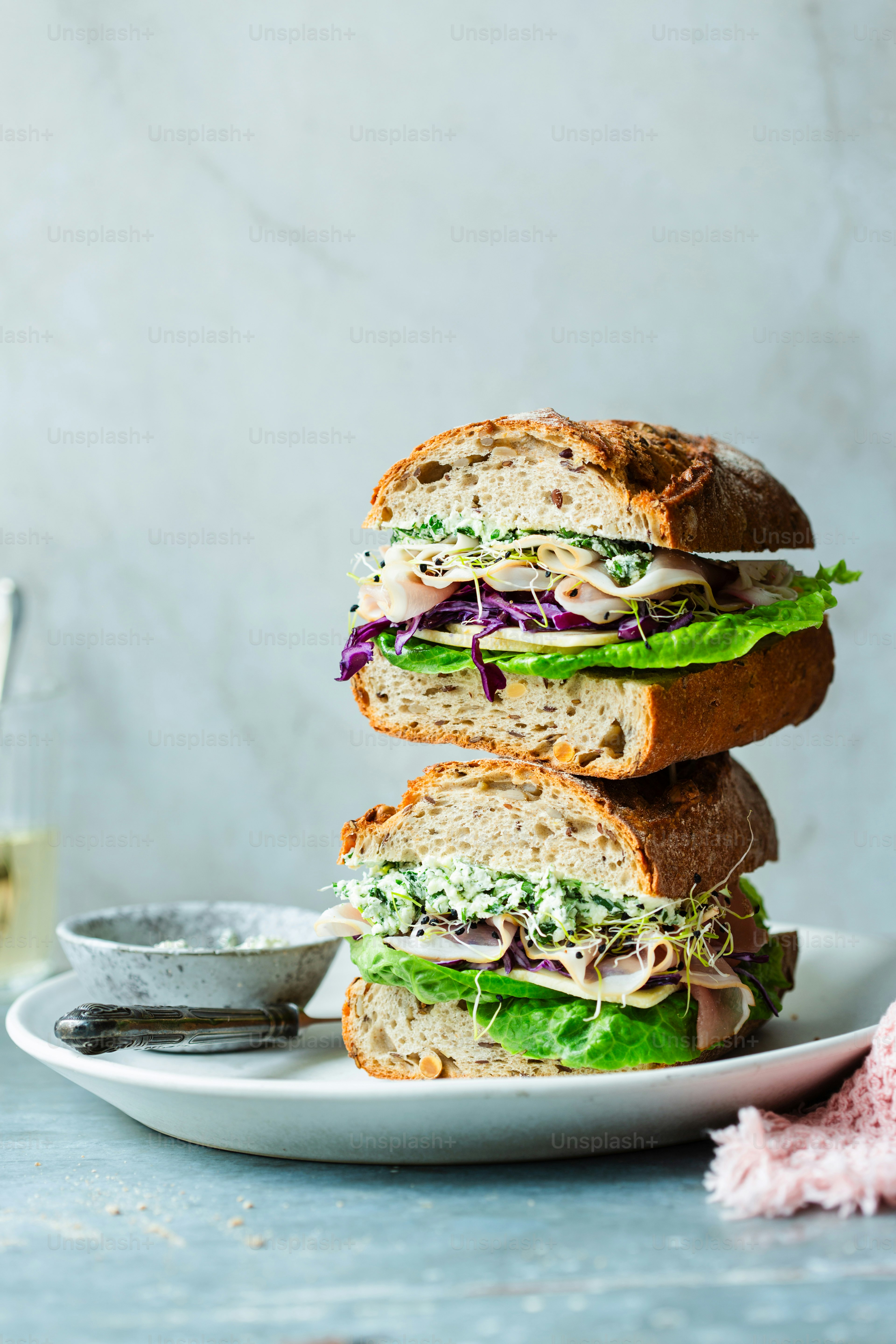 A stack of three sandwiches sitting on top of a white plate photo ...