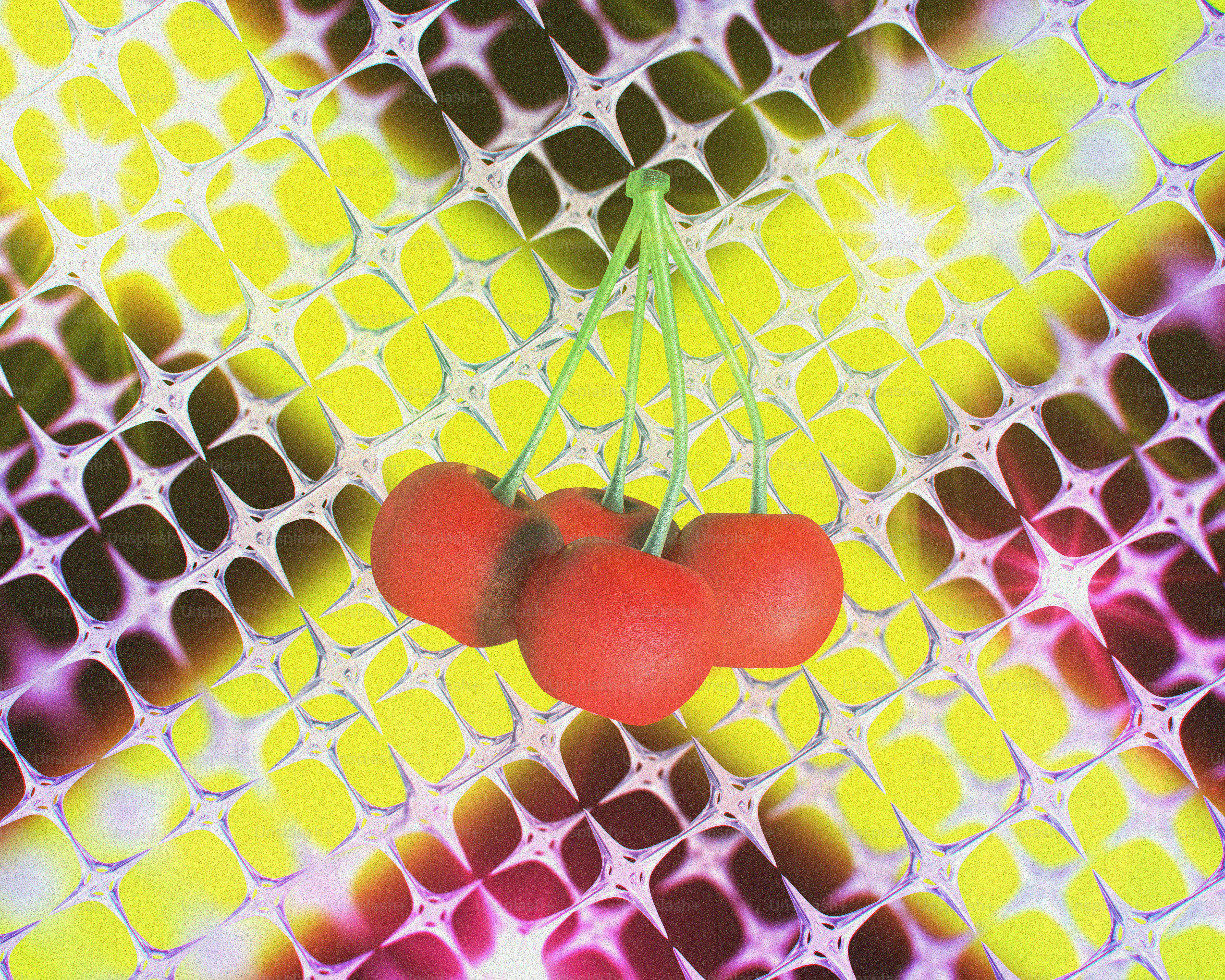Two cherries hanging from a string in front of a colorful background ...