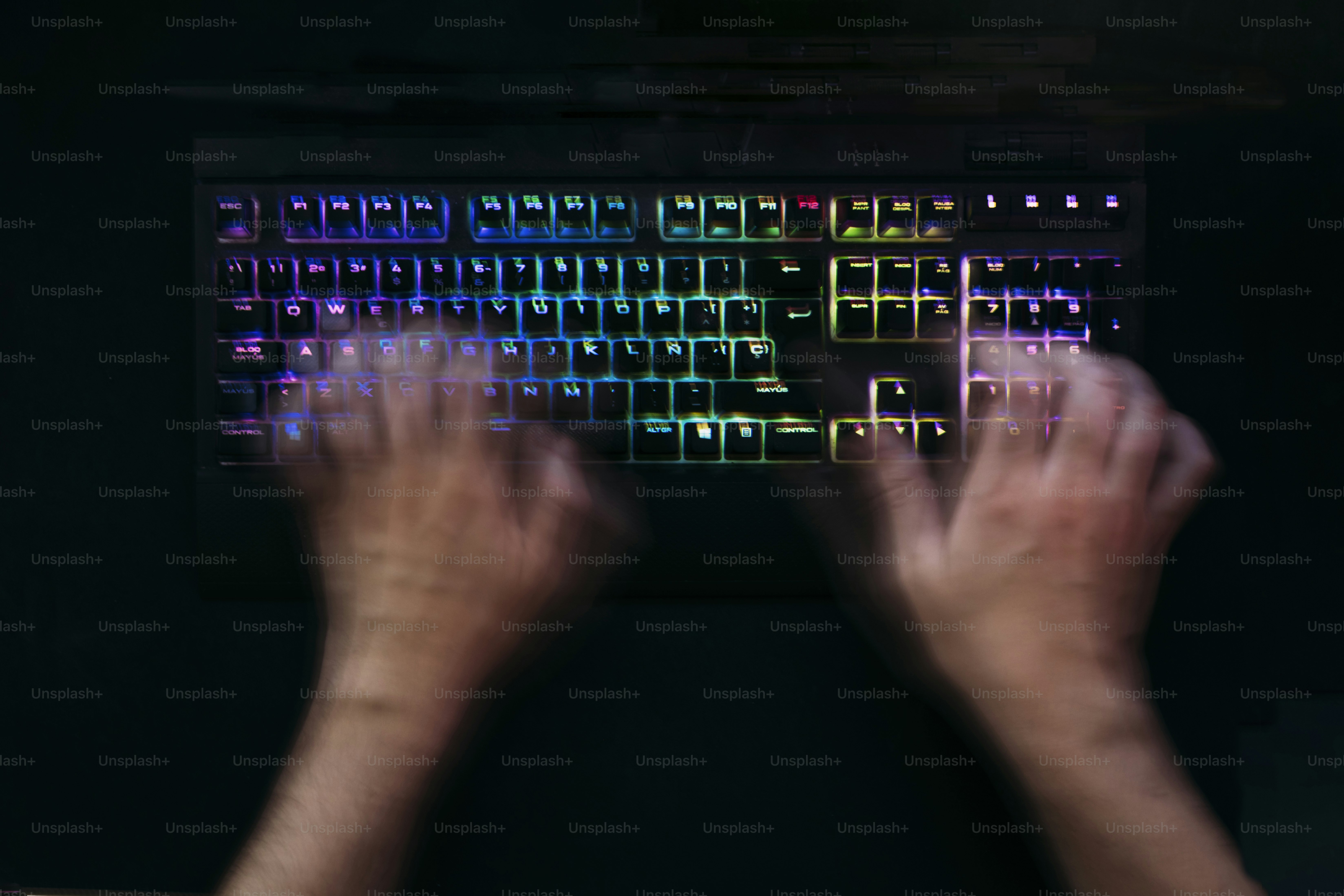 A person typing on a keyboard in a dark room photo – Keyboard Image on ...