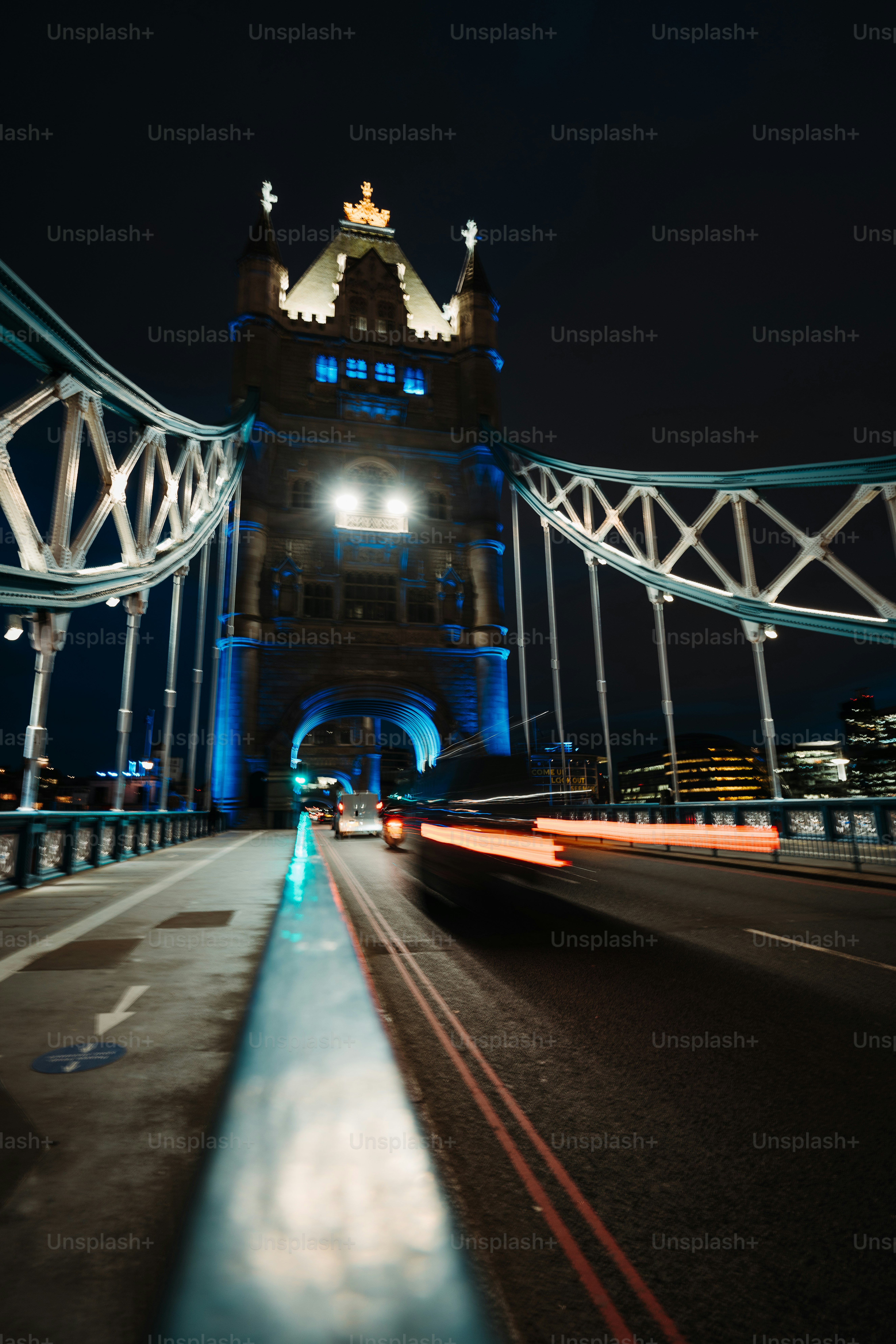 A car driving over a bridge at night photo – Movement Image on Unsplash
