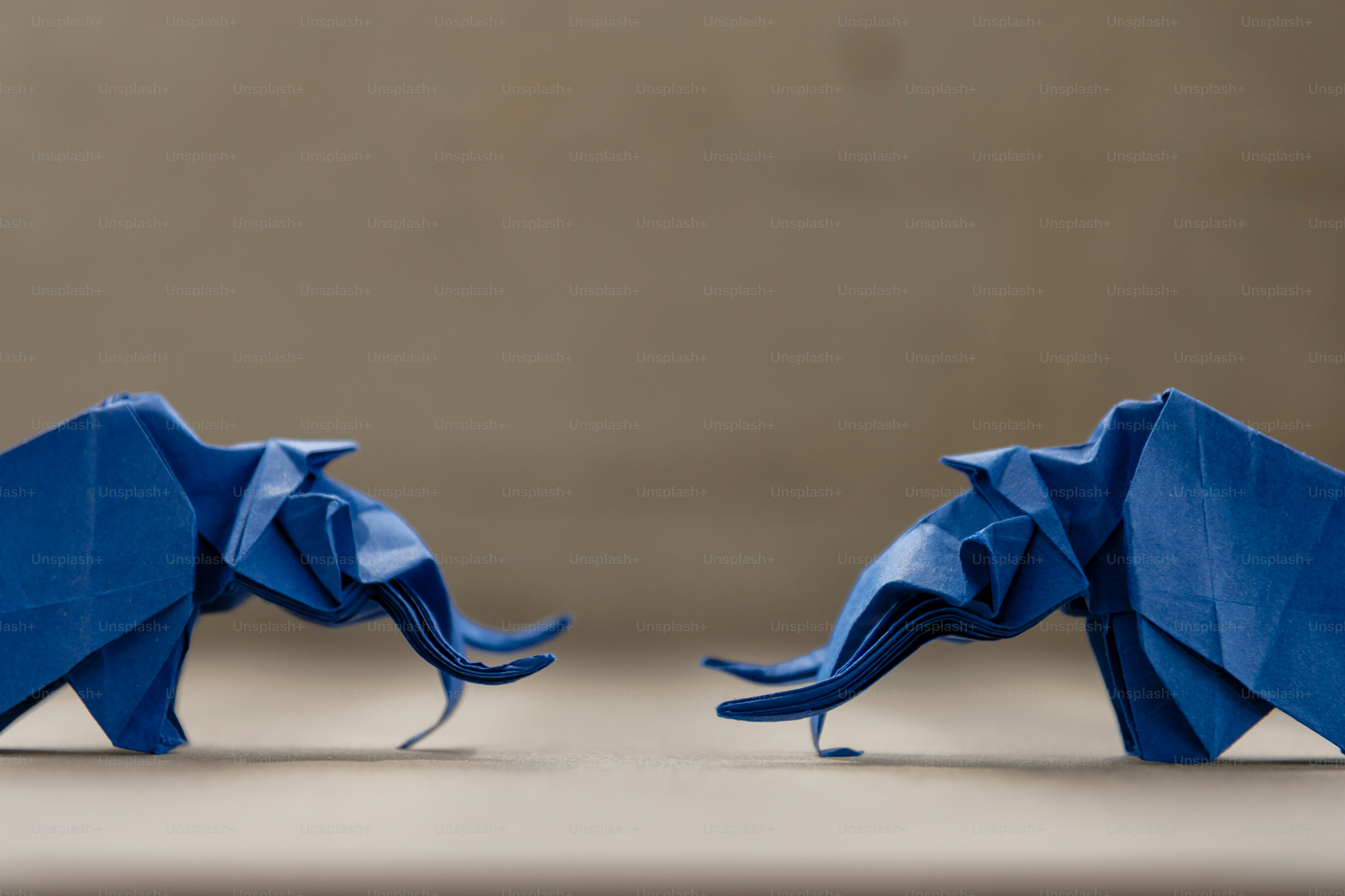 Two origami elephants are facing each other photo – Art Image on Unsplash