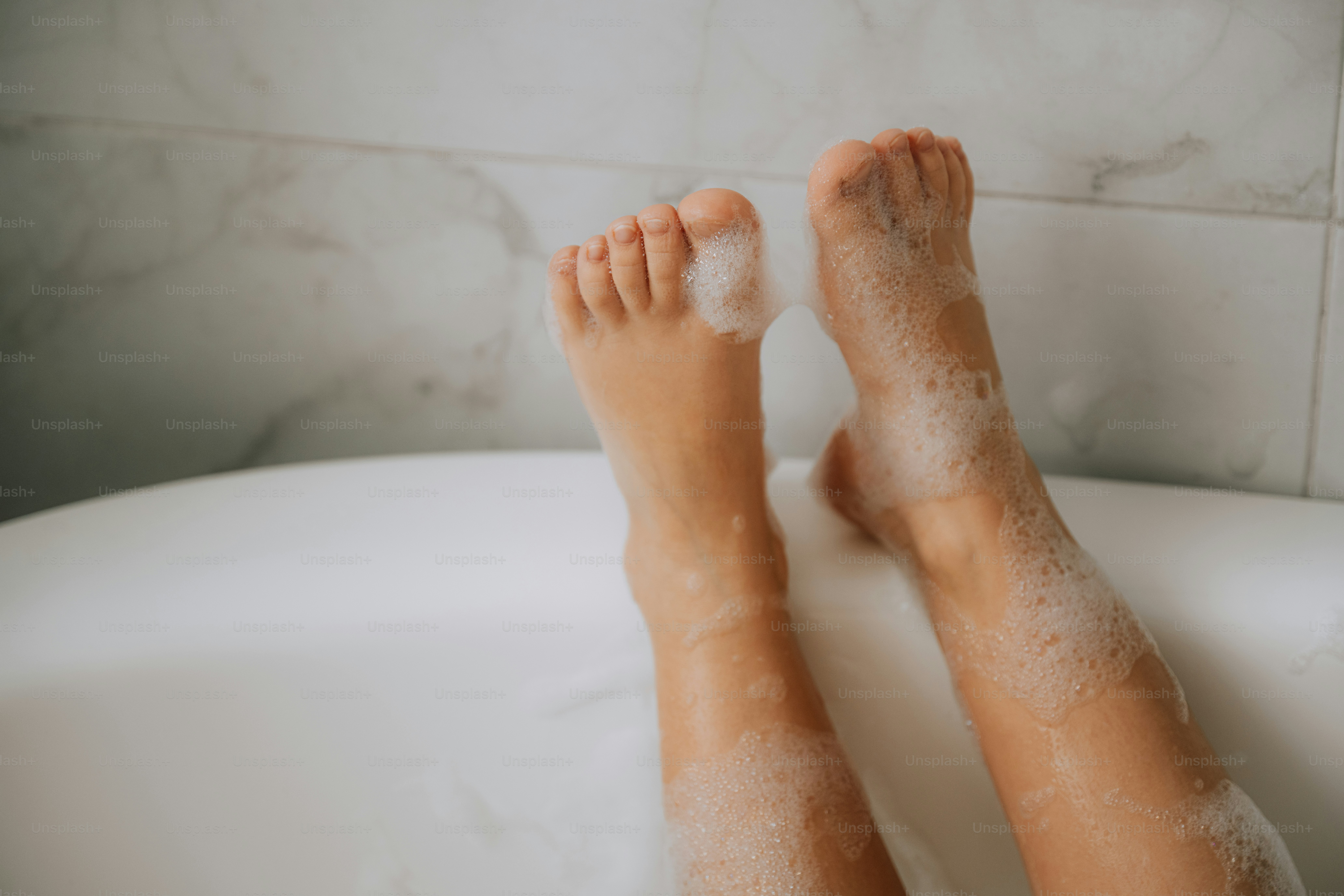 A close up of a person's feet in a bathtub photo – Self care Image on ...