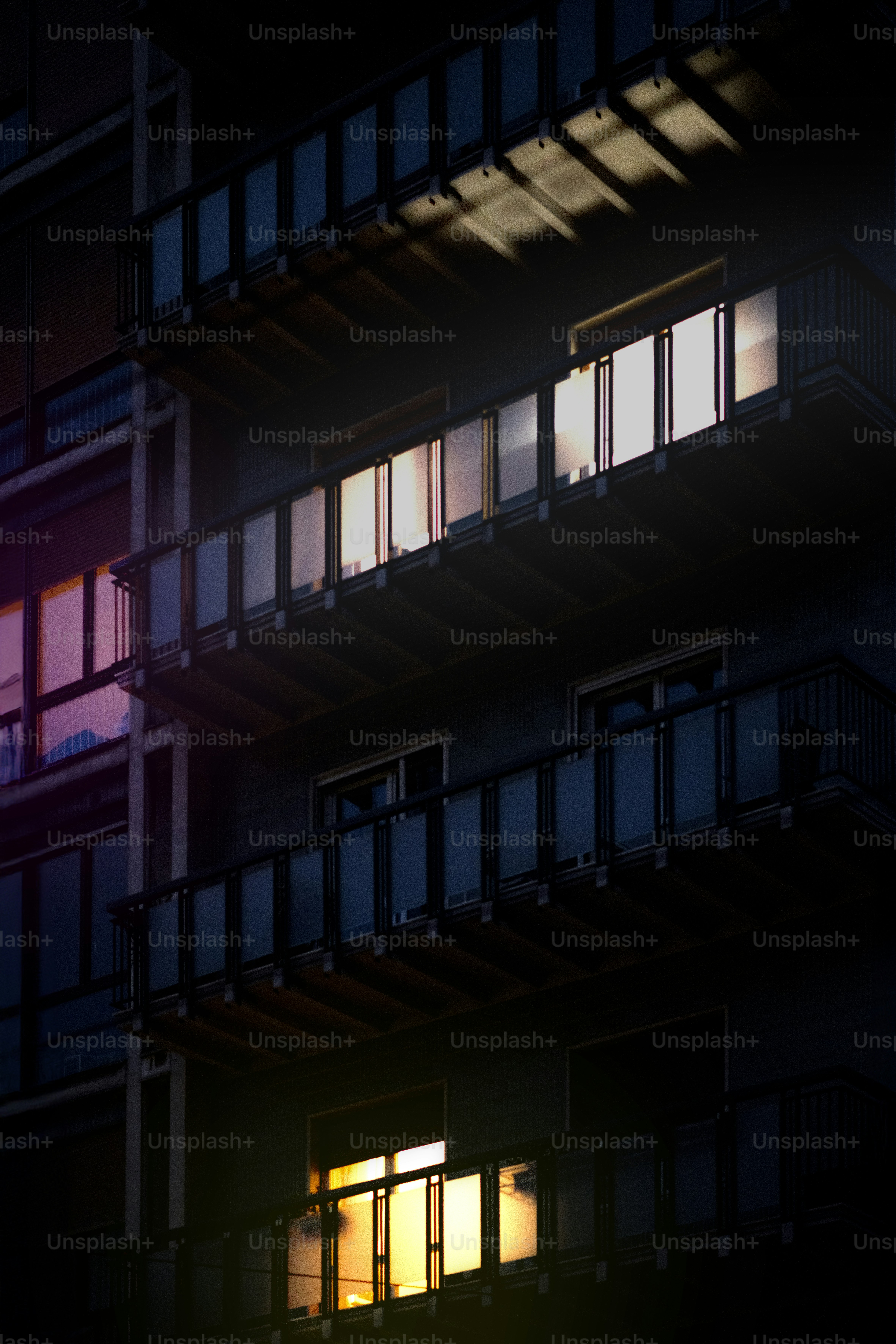 A tall building with windows lit up at night photo – City Image on Unsplash