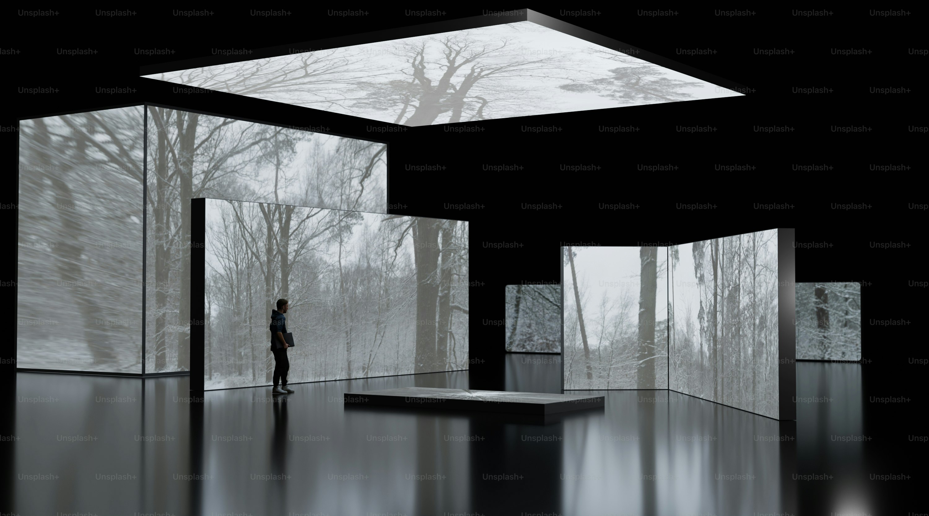 A person standing in a dark room with a light hanging from the ceiling ...