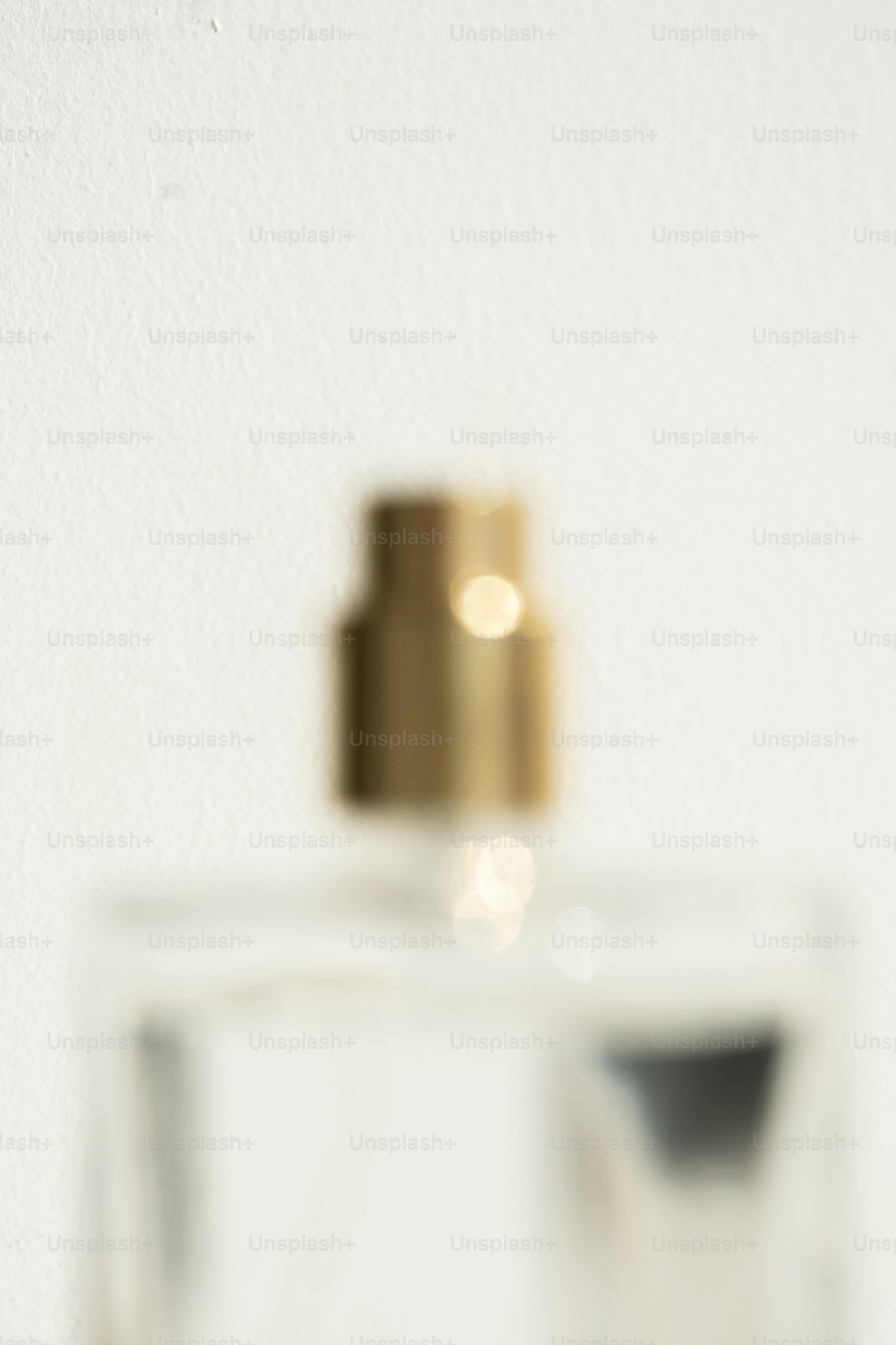 Un frasco de perfume sobre una superficie blanca foto – Imagen de ...