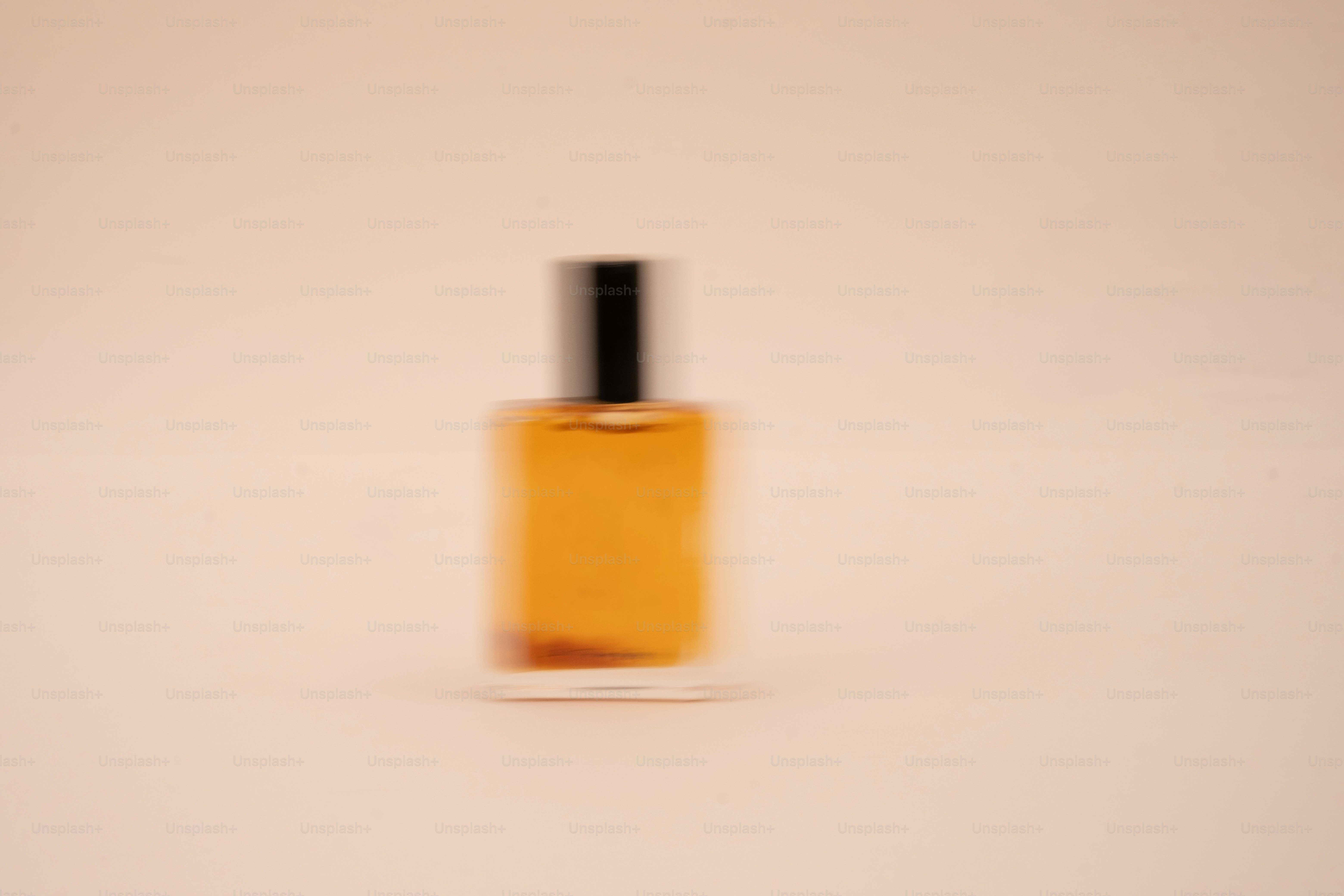 A bottle of perfume sitting on top of a table photo – Perfume Image on ...