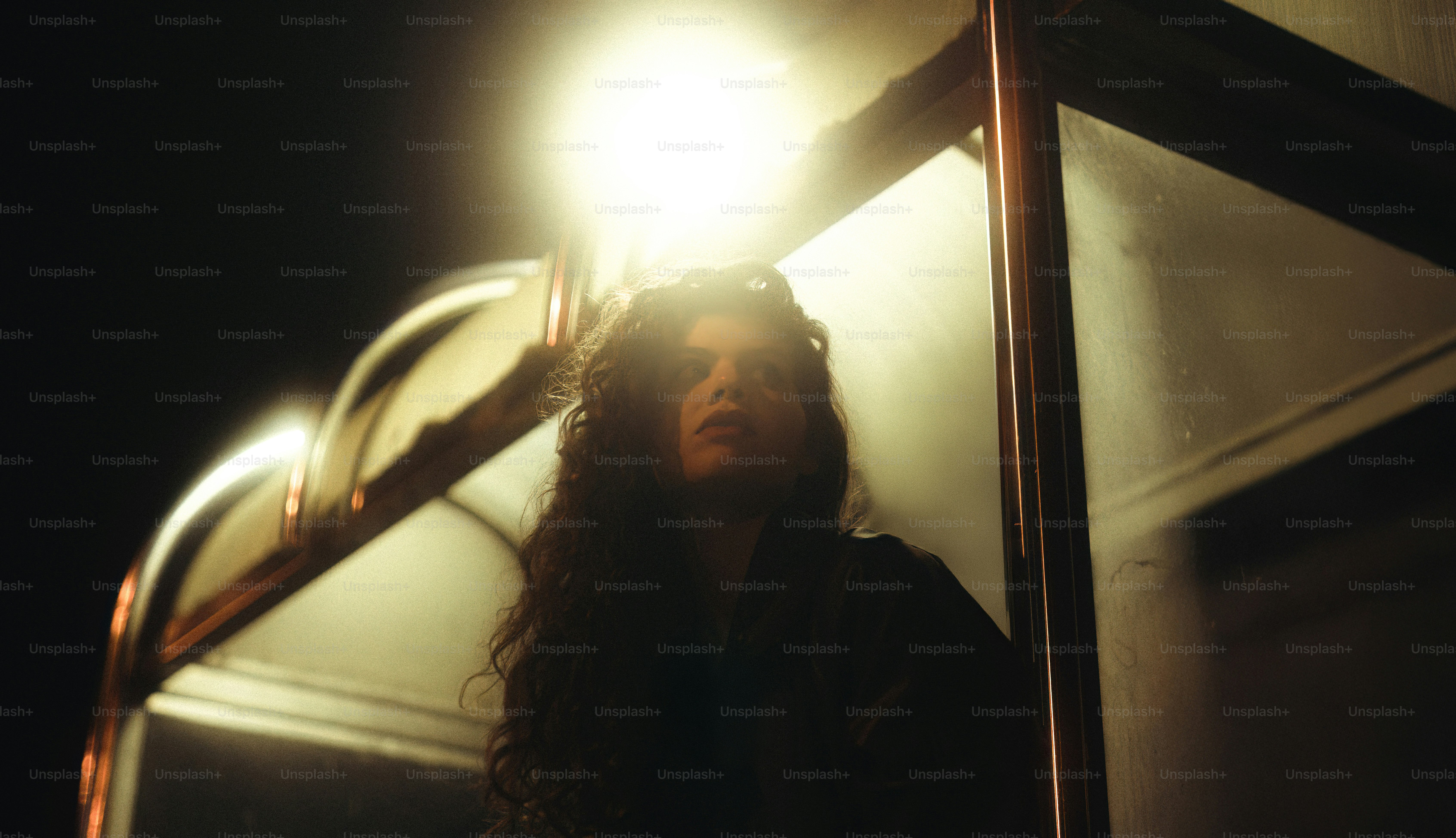 A woman standing in front of a mirror at night photo – City Image on ...