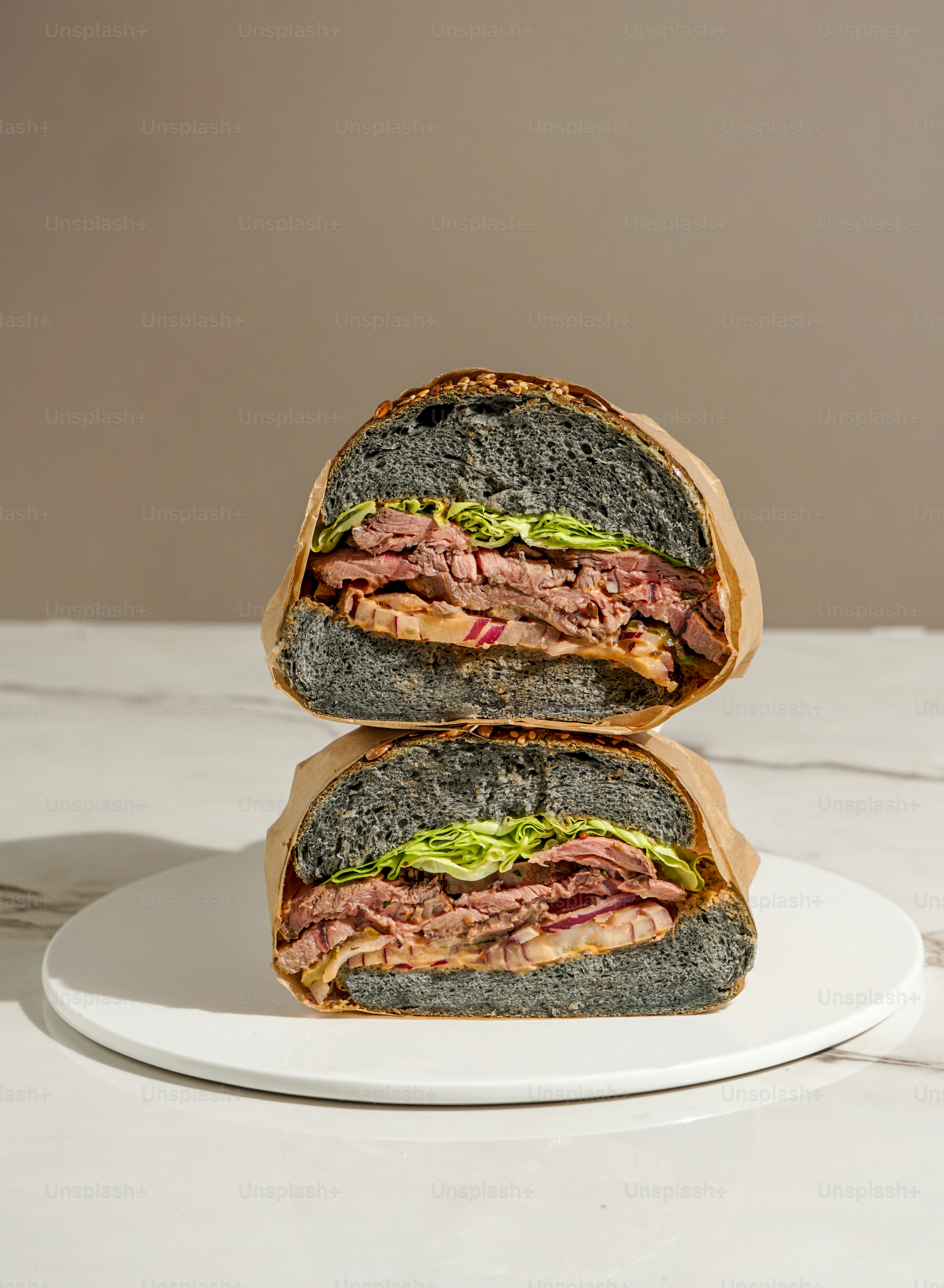 A cut in half sandwich sitting on top of a white plate photo – Food ...