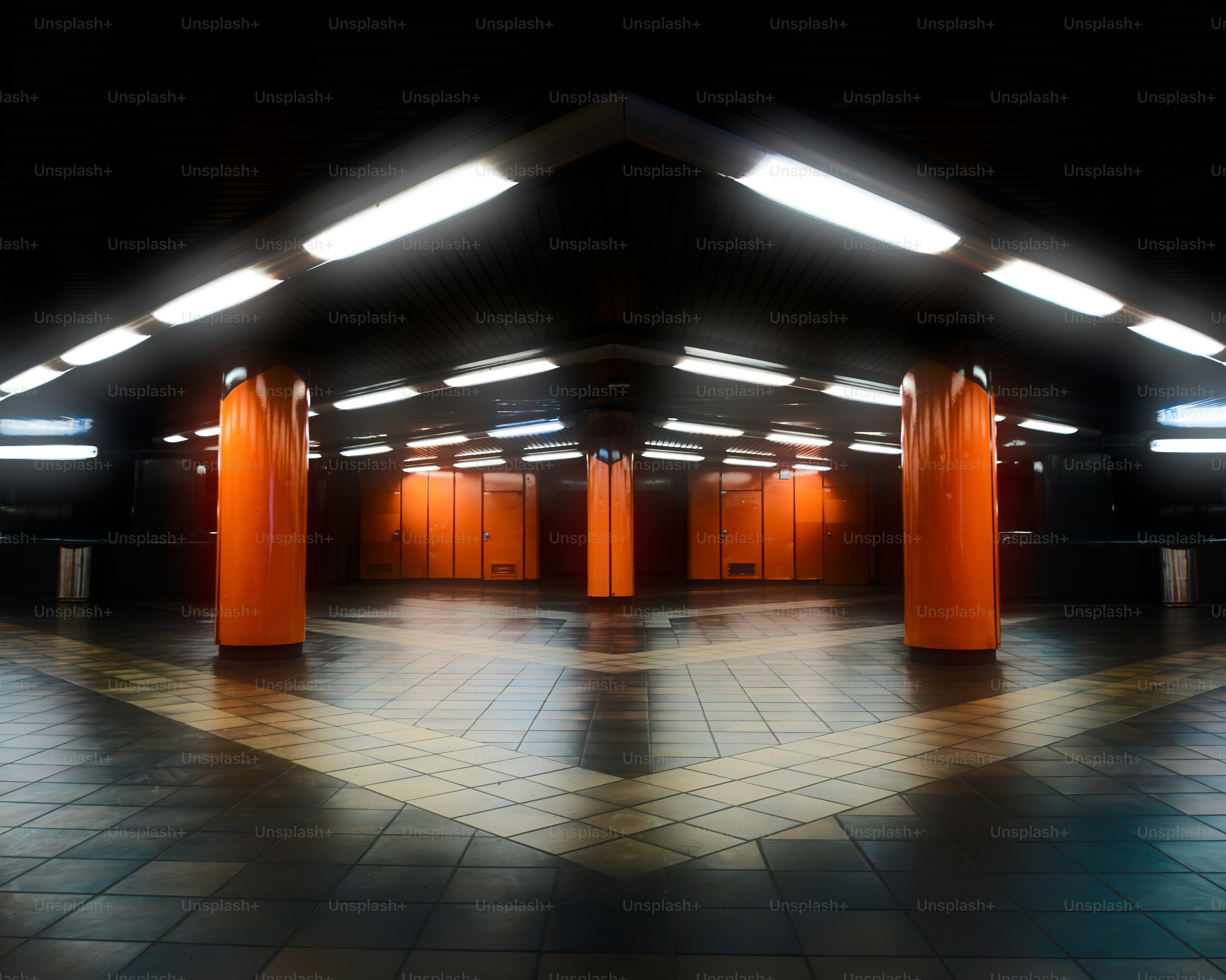An empty parking garage with orange stalls photo – City Image on Unsplash