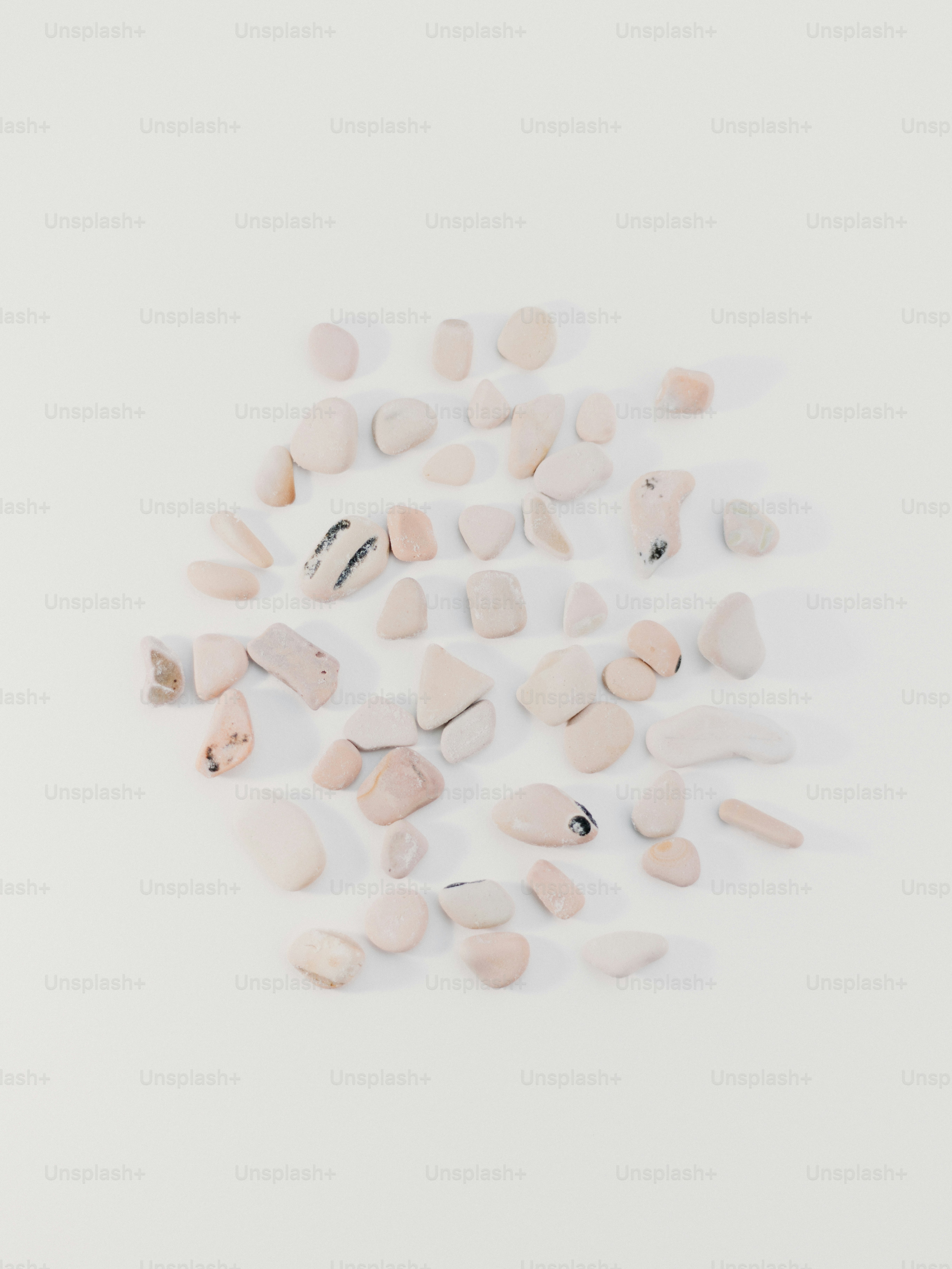 A pile of white rocks sitting on top of a white table photo – Natural ...