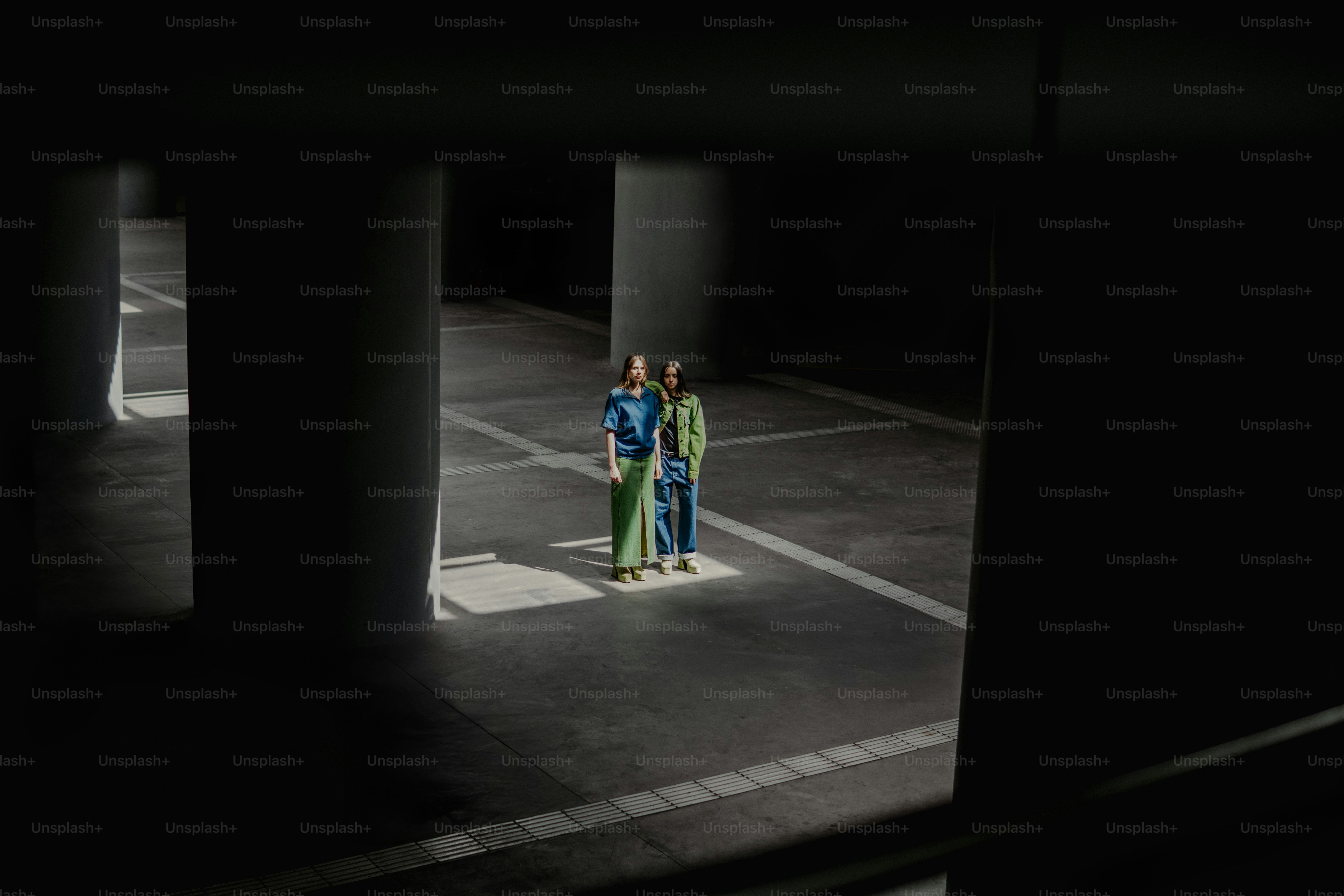 Two people standing in an empty parking lot photo – Fashion Image on ...