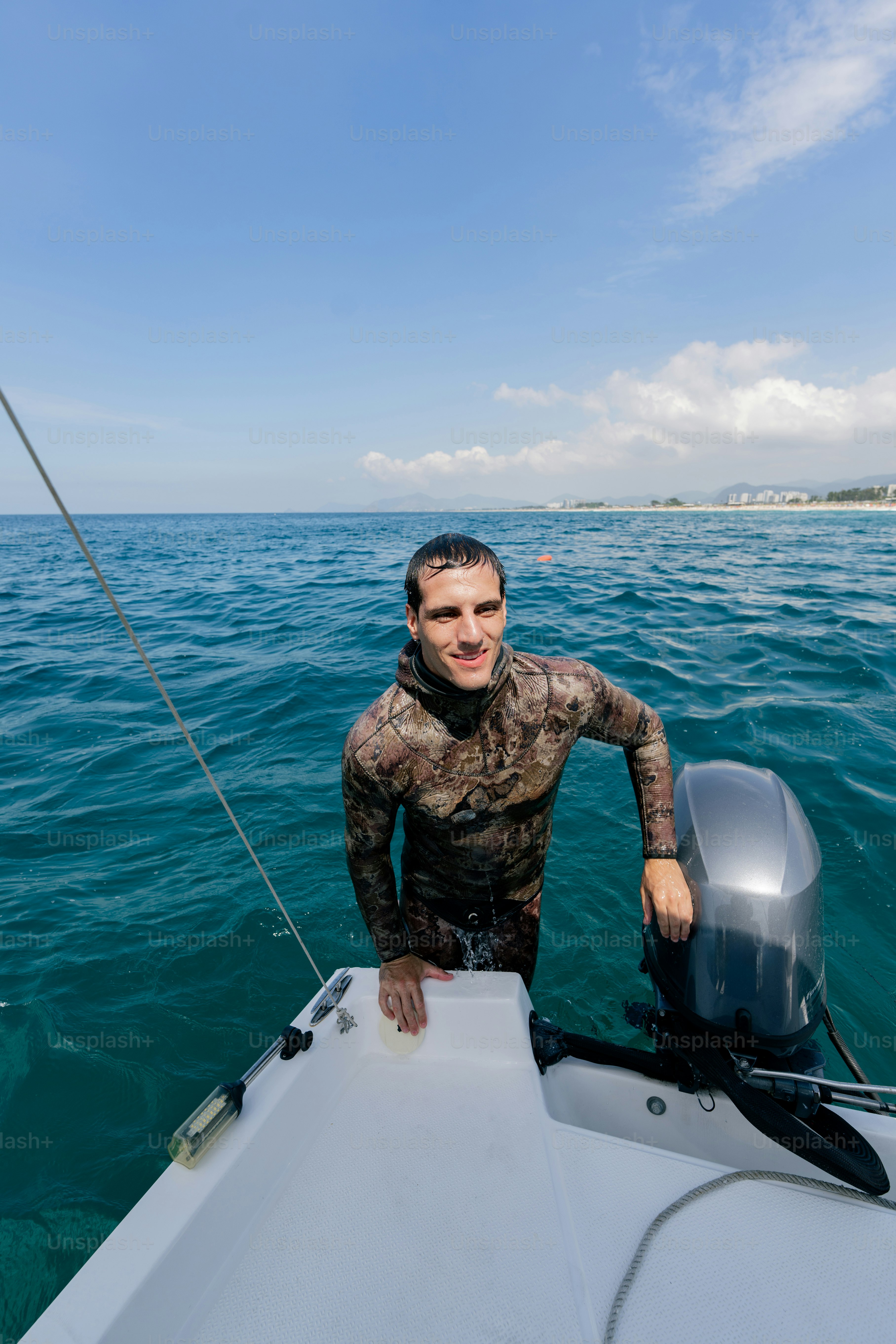 A man standing on a boat in the water photo – Man Image on Unsplash