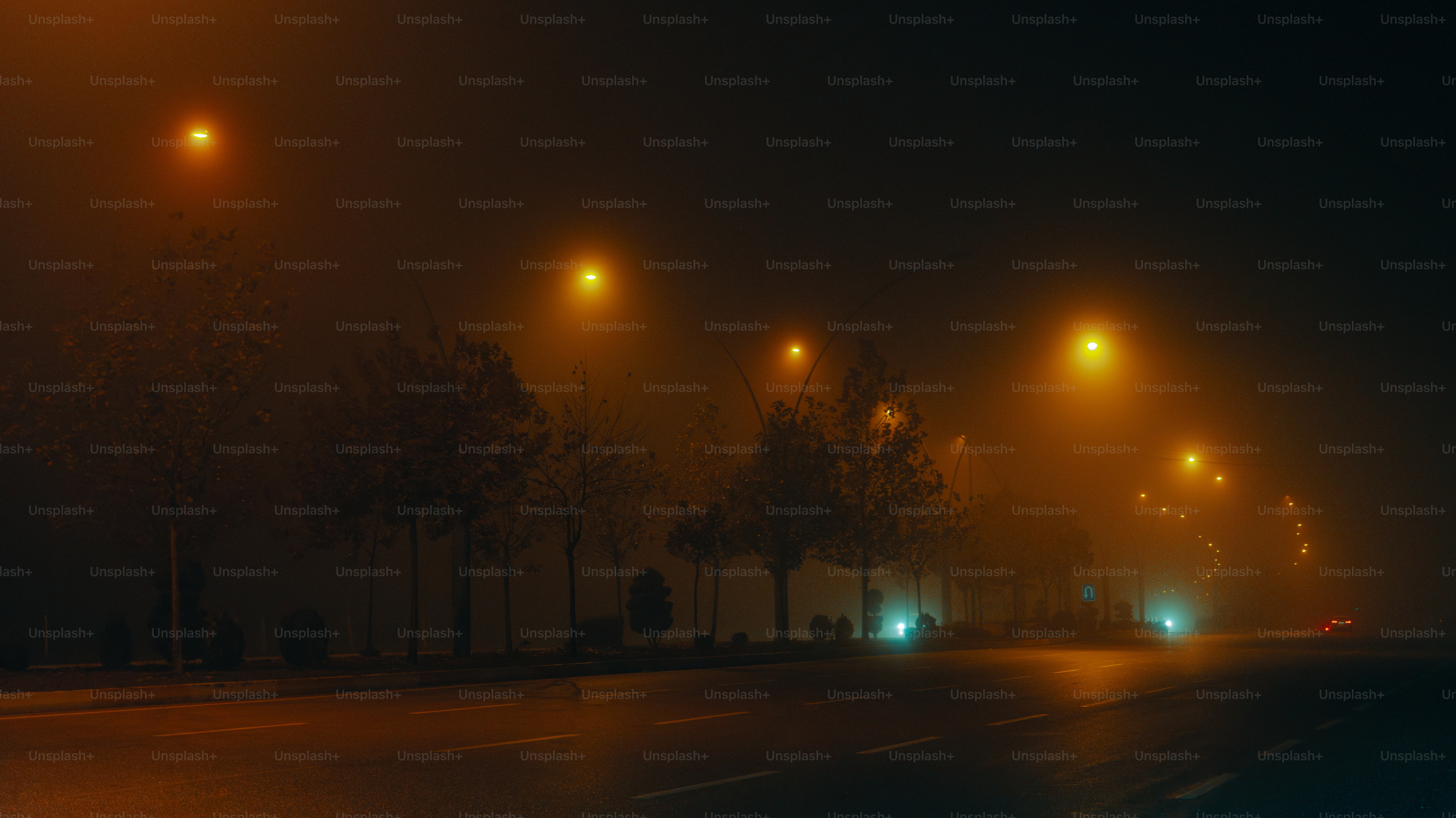 A foggy street at night with street lights photo – City Image on Unsplash
