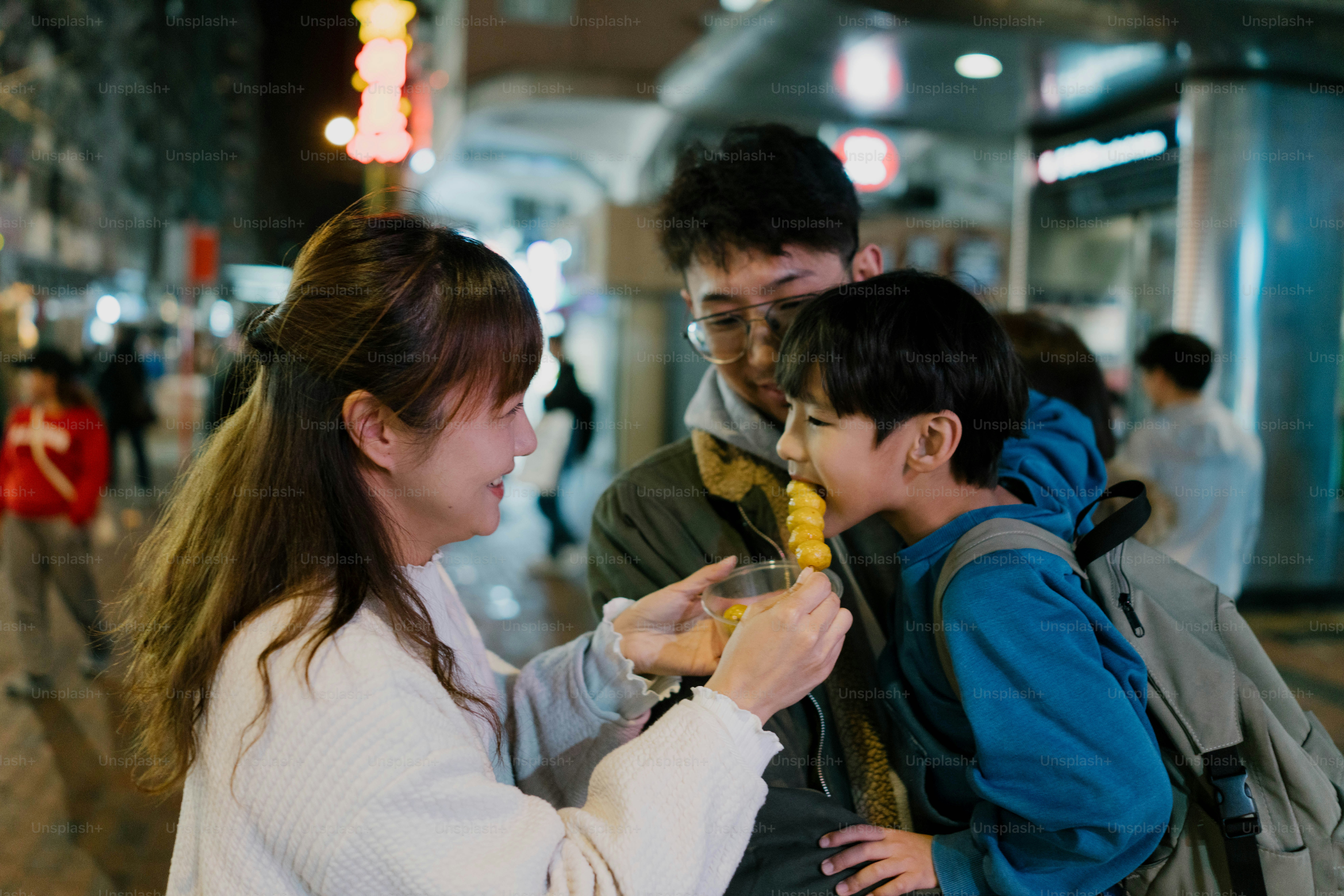 A group of people standing around each other photo – Travel Image on ...