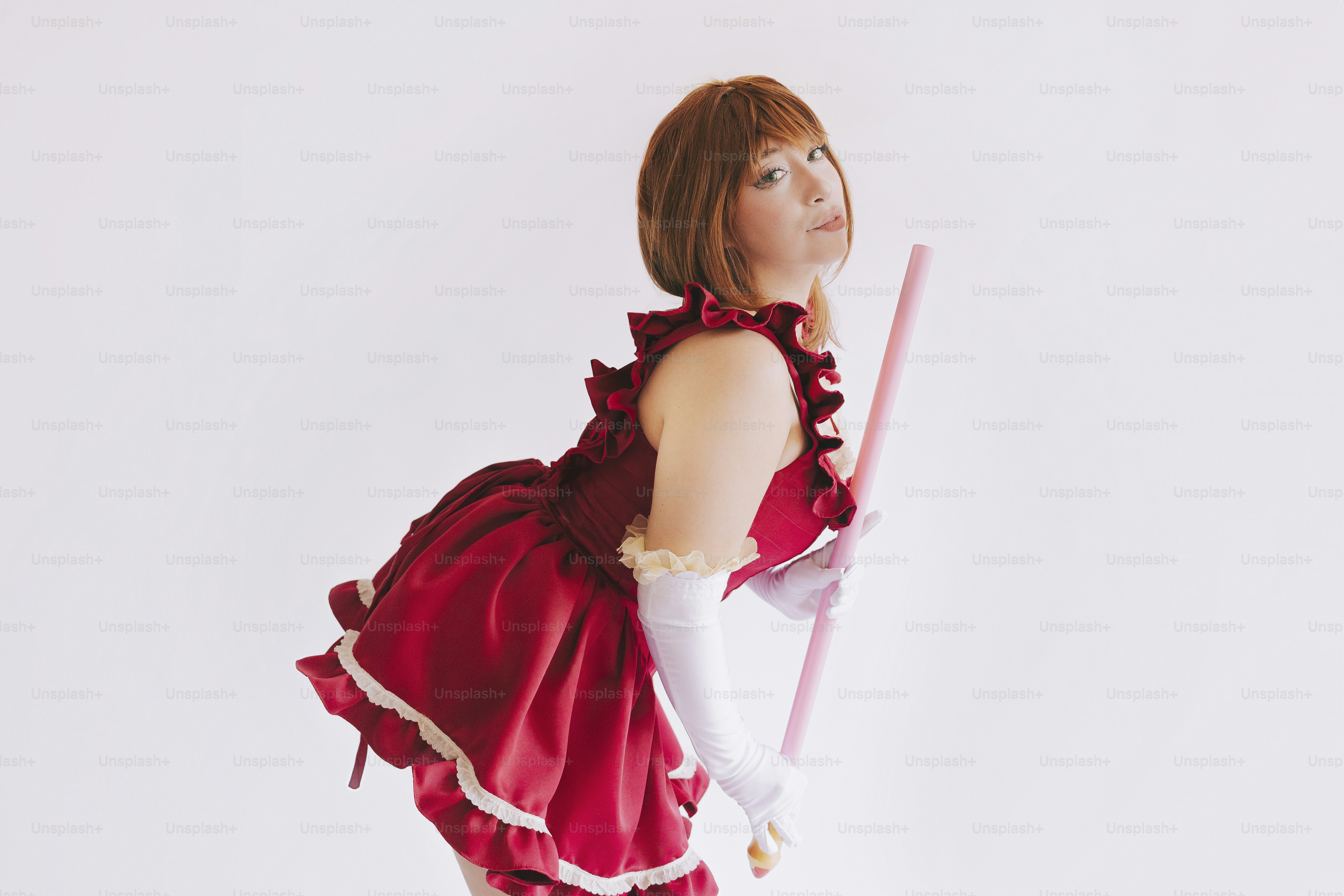 Woman poses in a red costume with a pink pole. photo – Character Image ...