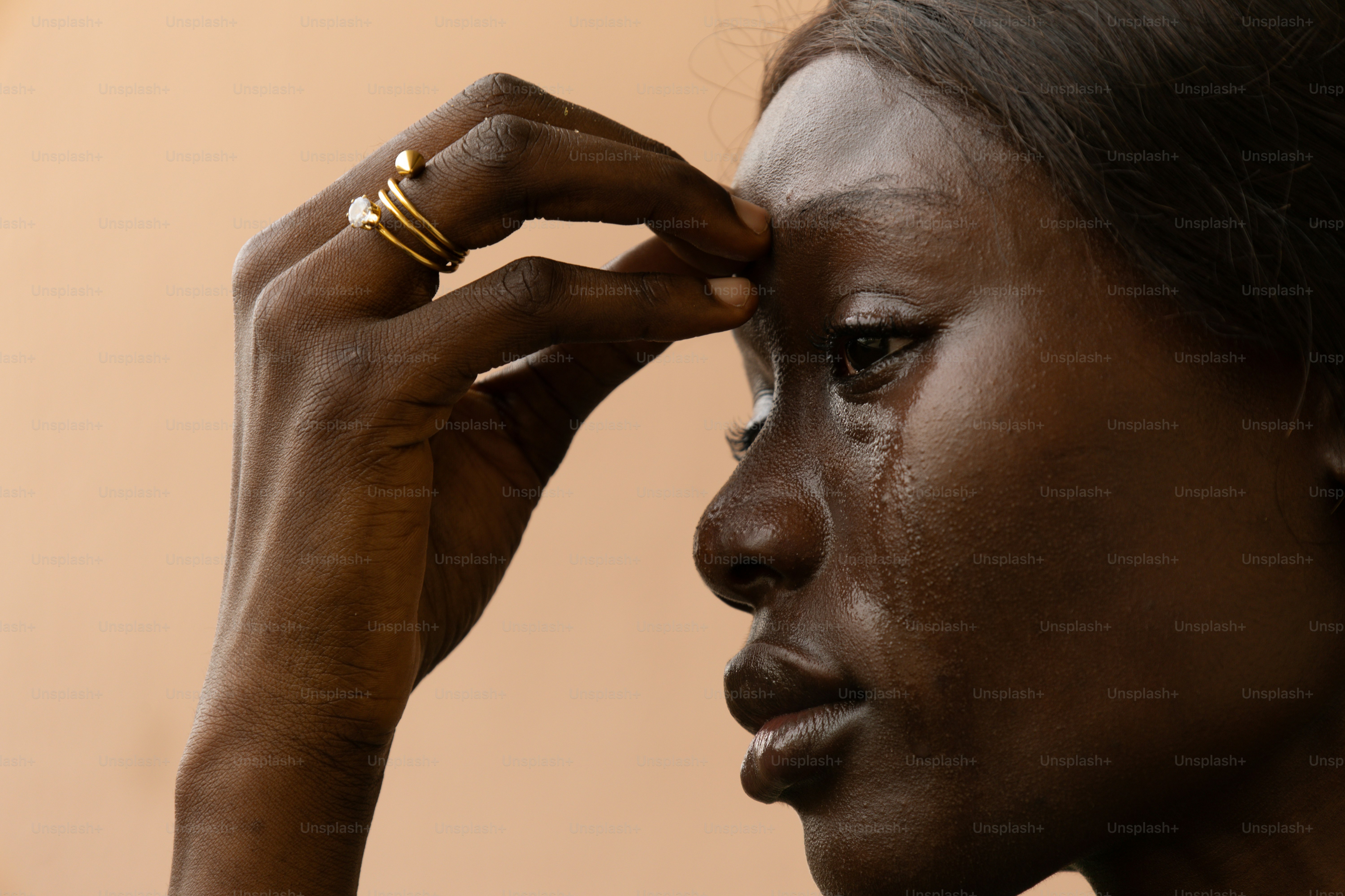 A woman is crying and covering her forehead. photo – Sad Image on Unsplash