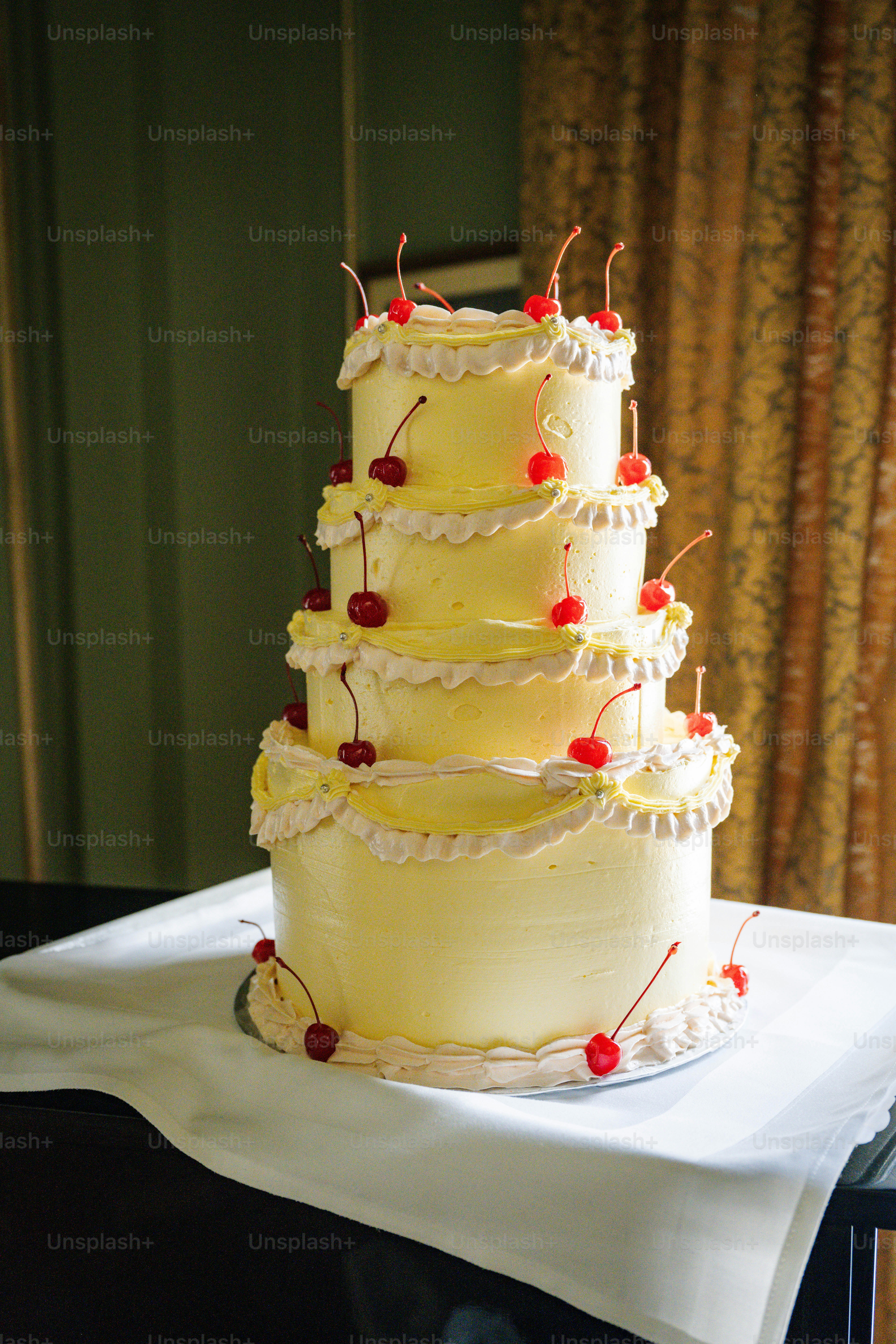 A two-tiered cake decorated with cherries. photo – Cake Image on Unsplash
