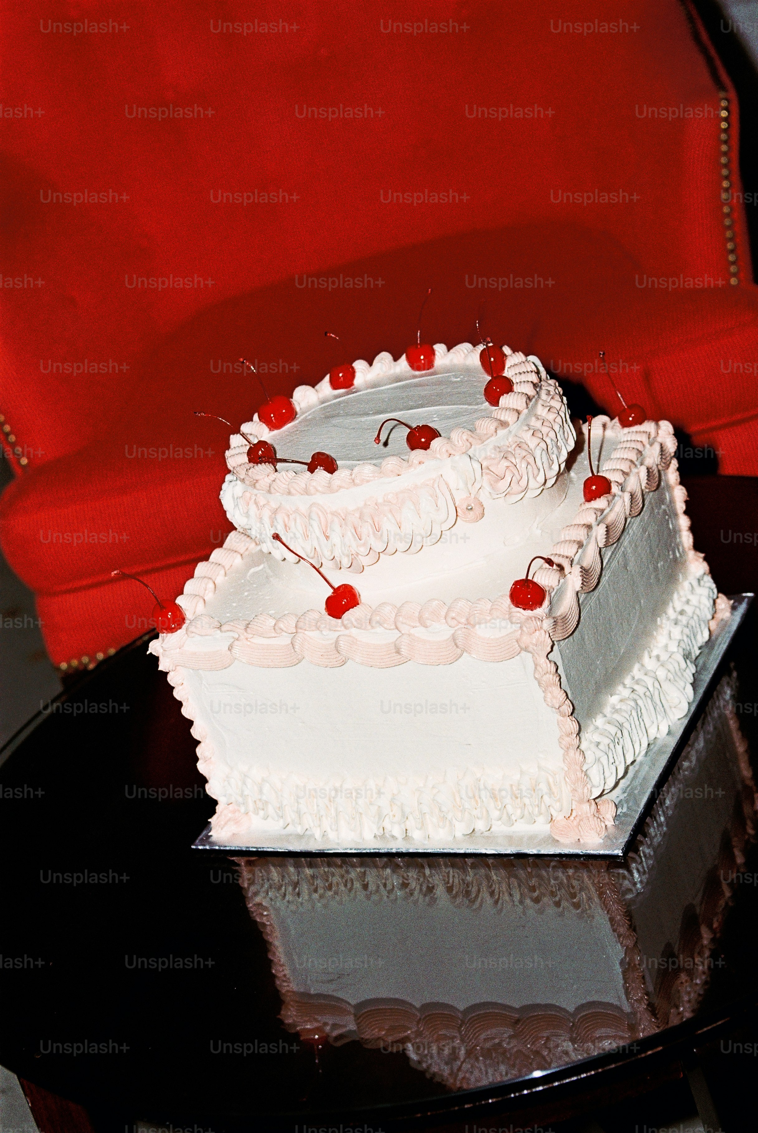 Two-tiered cake decorated with cherries. photo – Cake Image on Unsplash