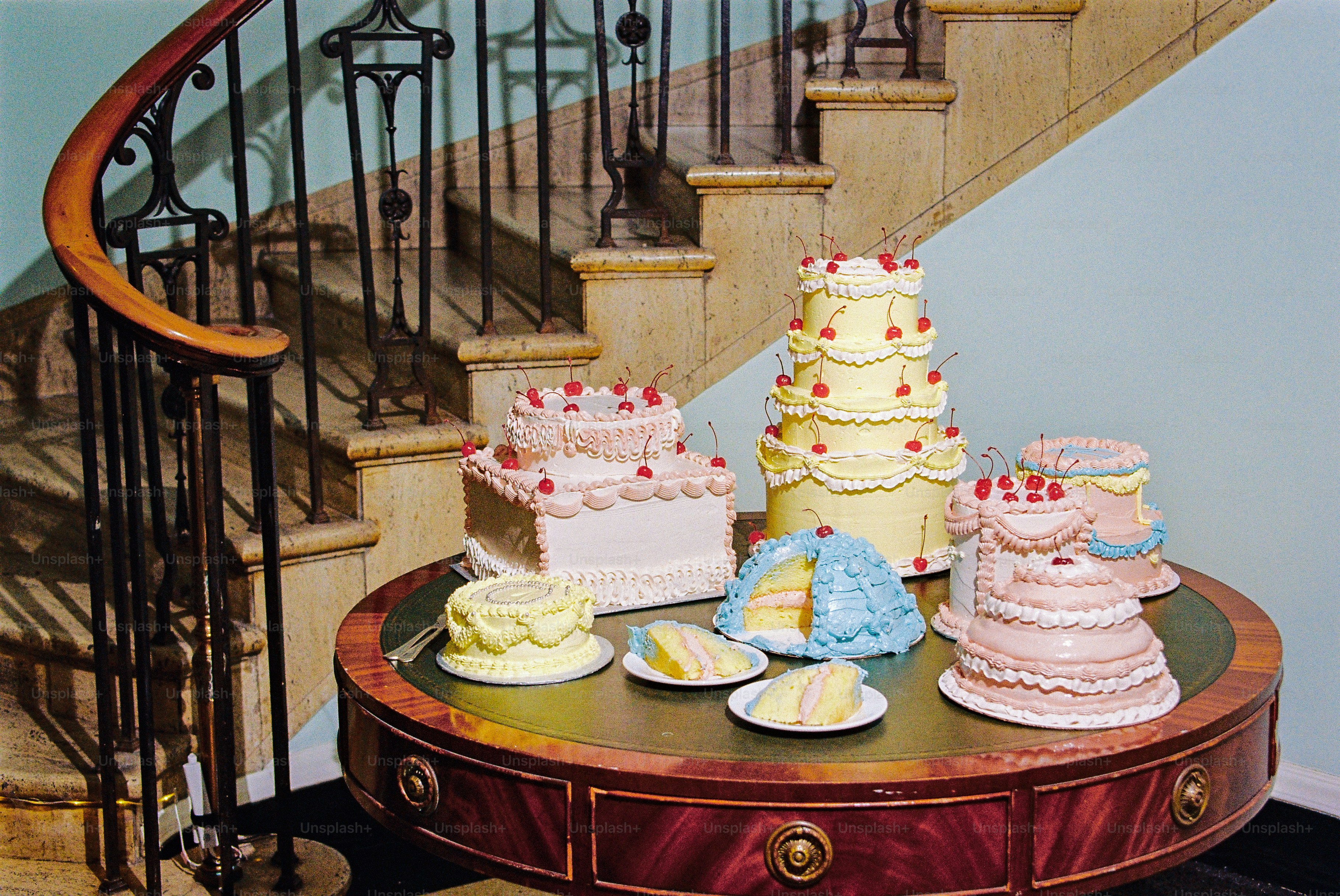 A two-tiered cake adorned with cherries. photo – Cake Image on Unsplash