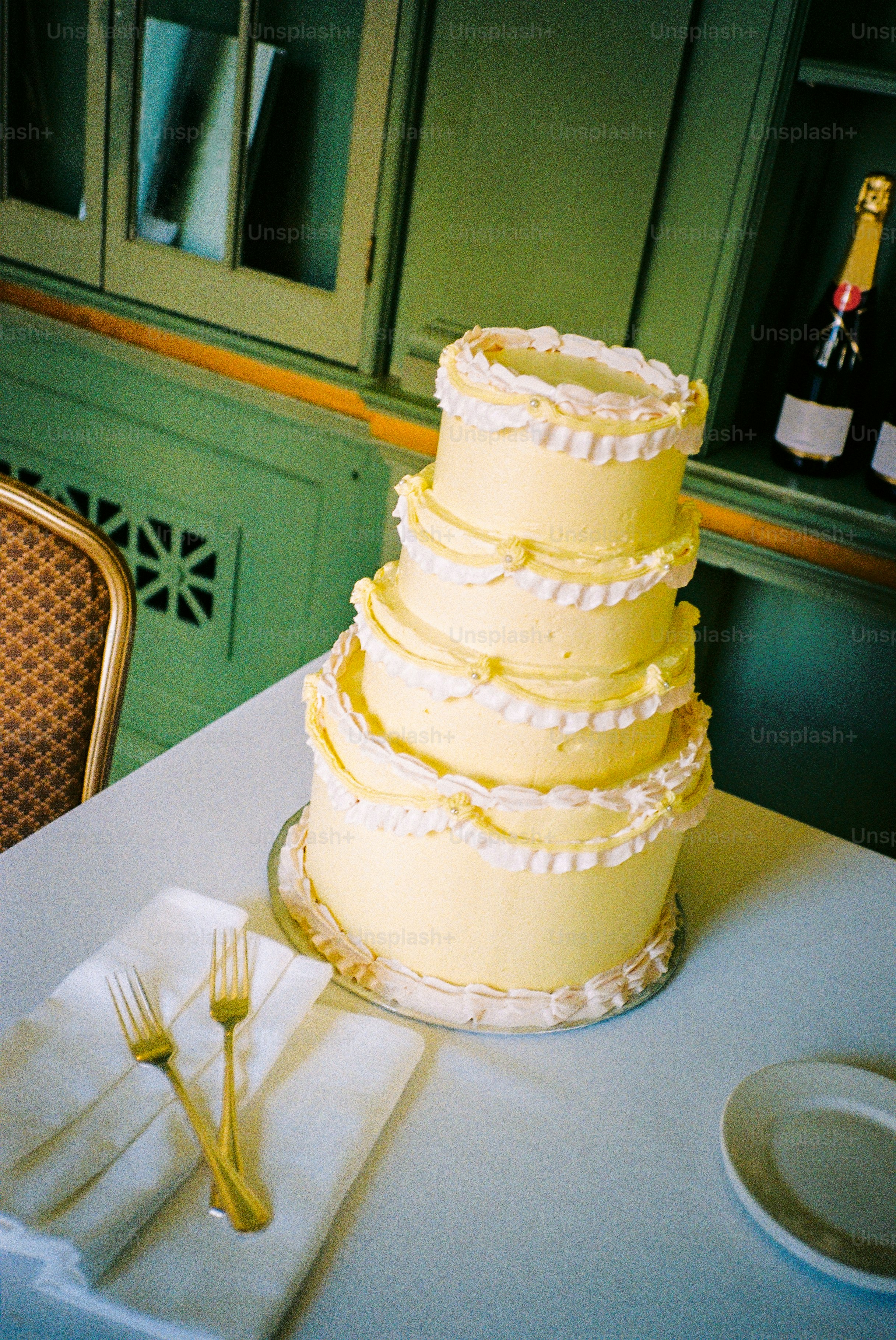 A beautiful, multi-tiered wedding cake is on display. photo – Cake ...