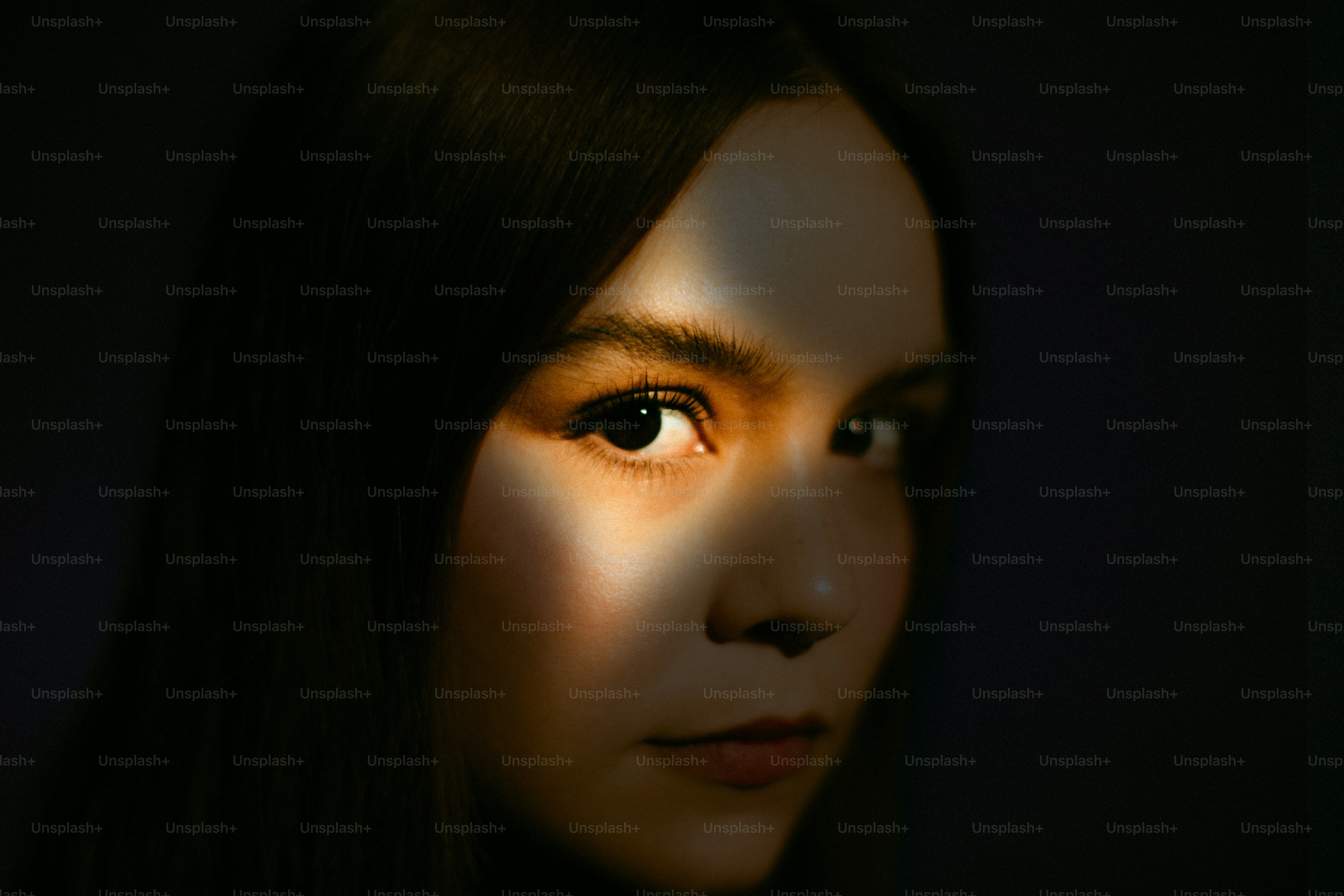 Woman's face lit by a strip of light. photo – Portrait Image on Unsplash