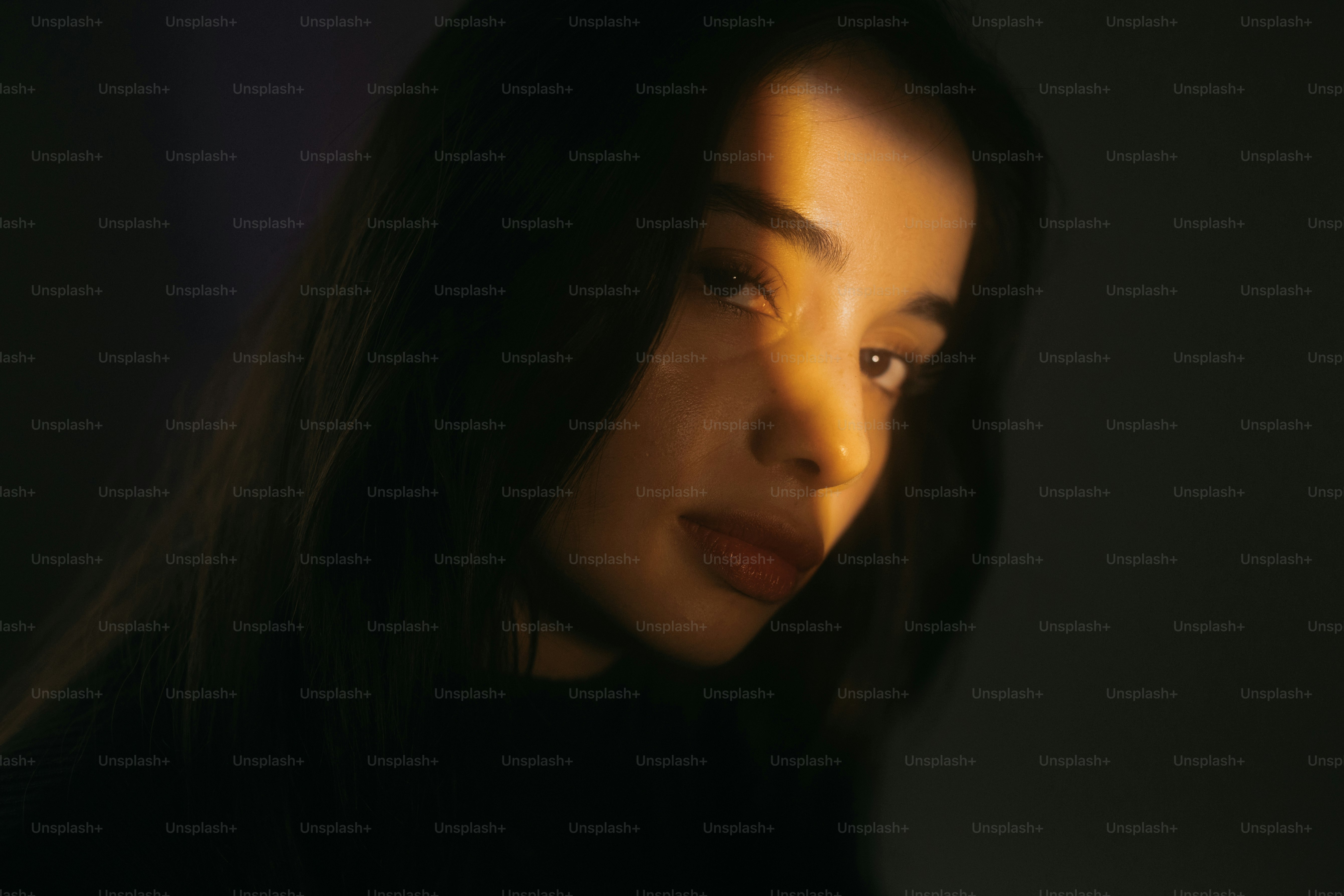 A woman gazes, lit by warm, dramatic light. photo – Portrait Image on ...