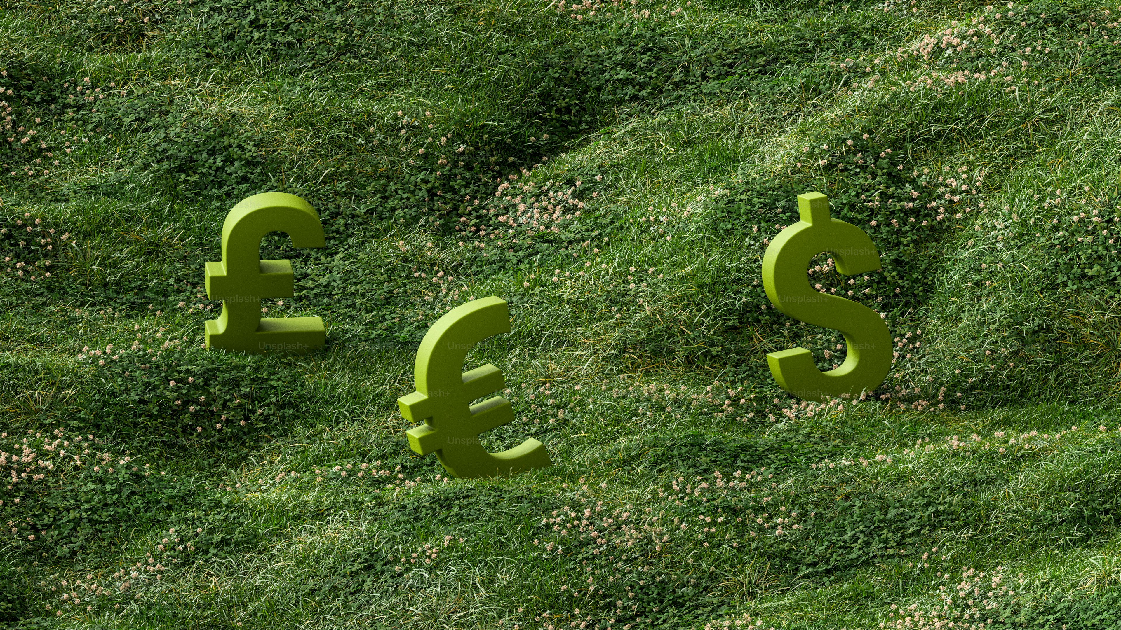 Currency symbols sit on a field of green grass. photo – Abstract Image ...